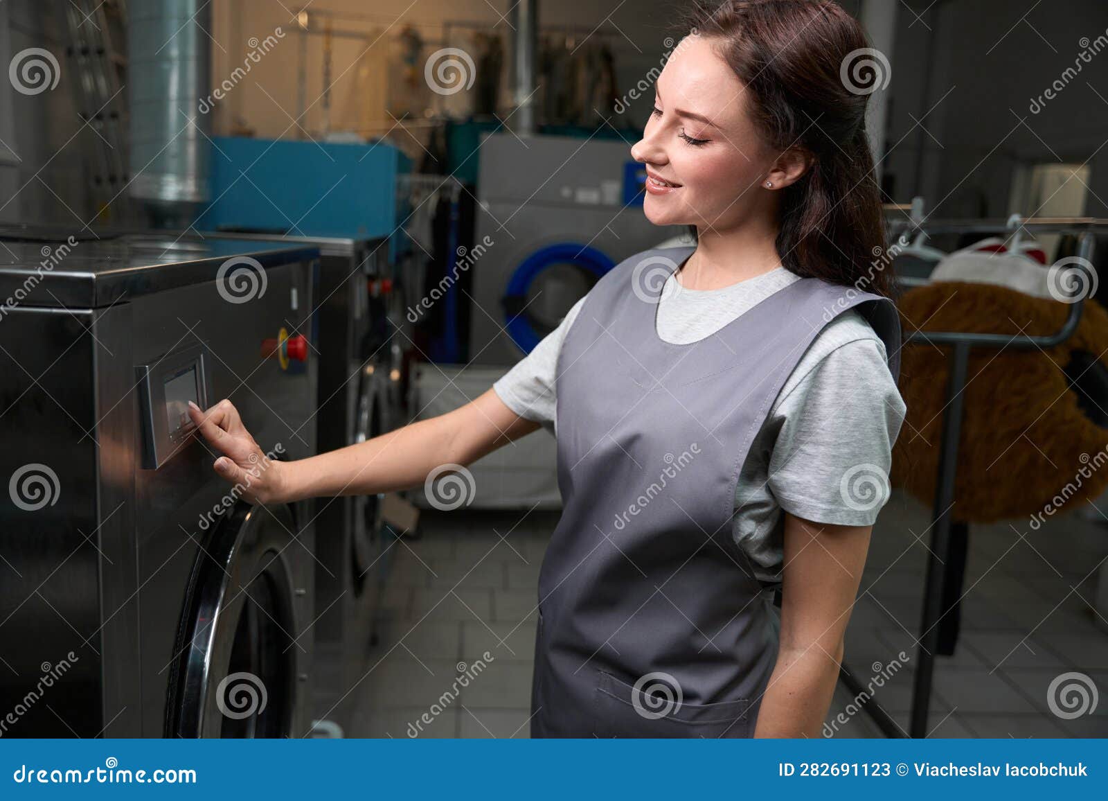Woman Laundry Worker is Programming Washing Machine Stock Image - Image ...