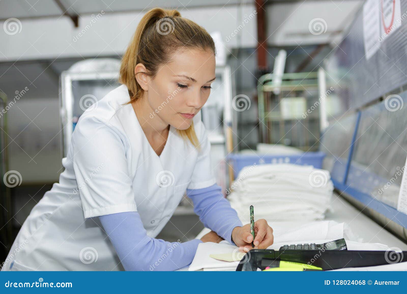 Woman Laundry Worker Writing Notes Stock Photo - Image of industrial ...