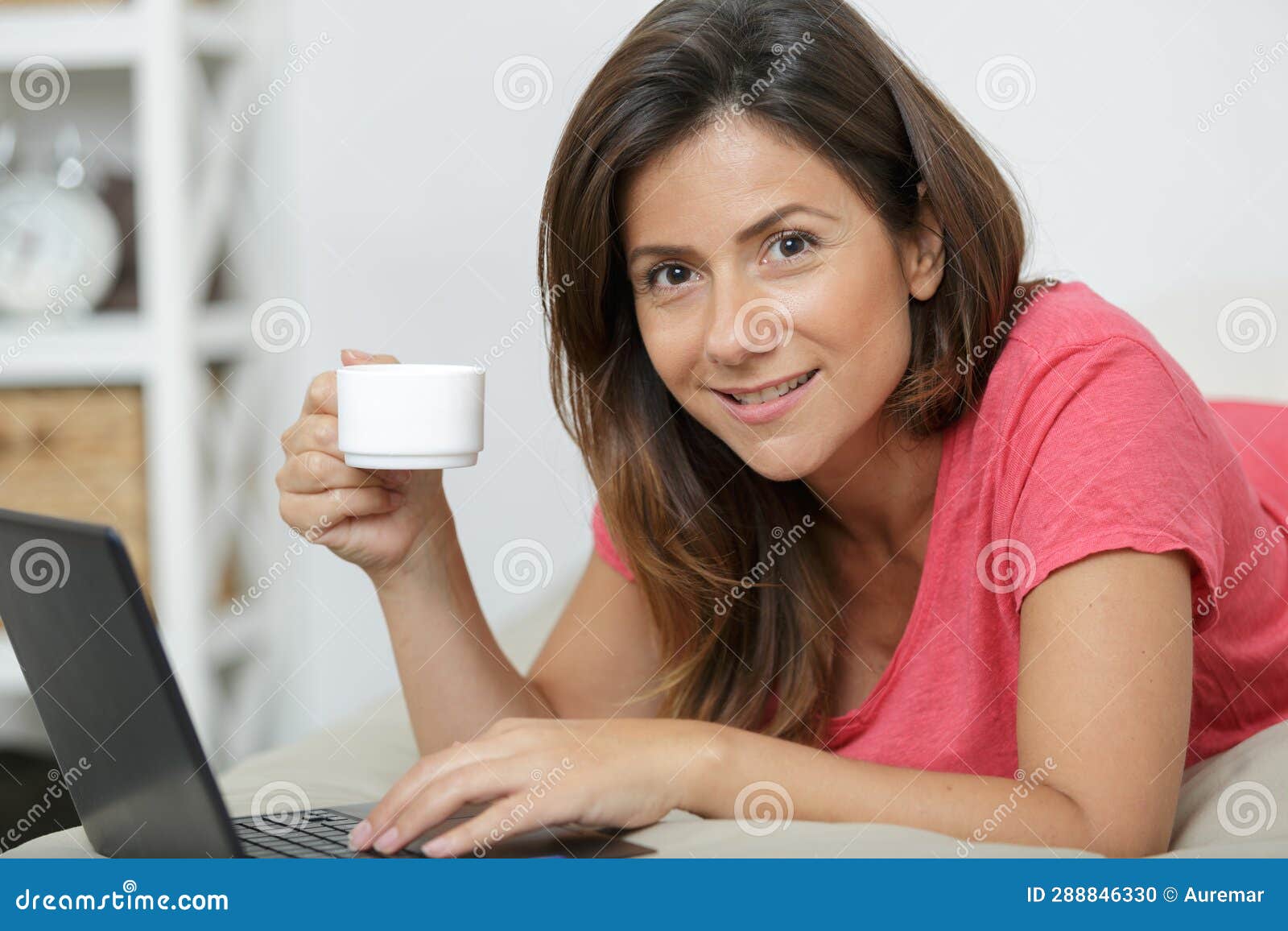 Woman Layed on Bed Drinking Coffee and Using Notebook Stock Photo ...