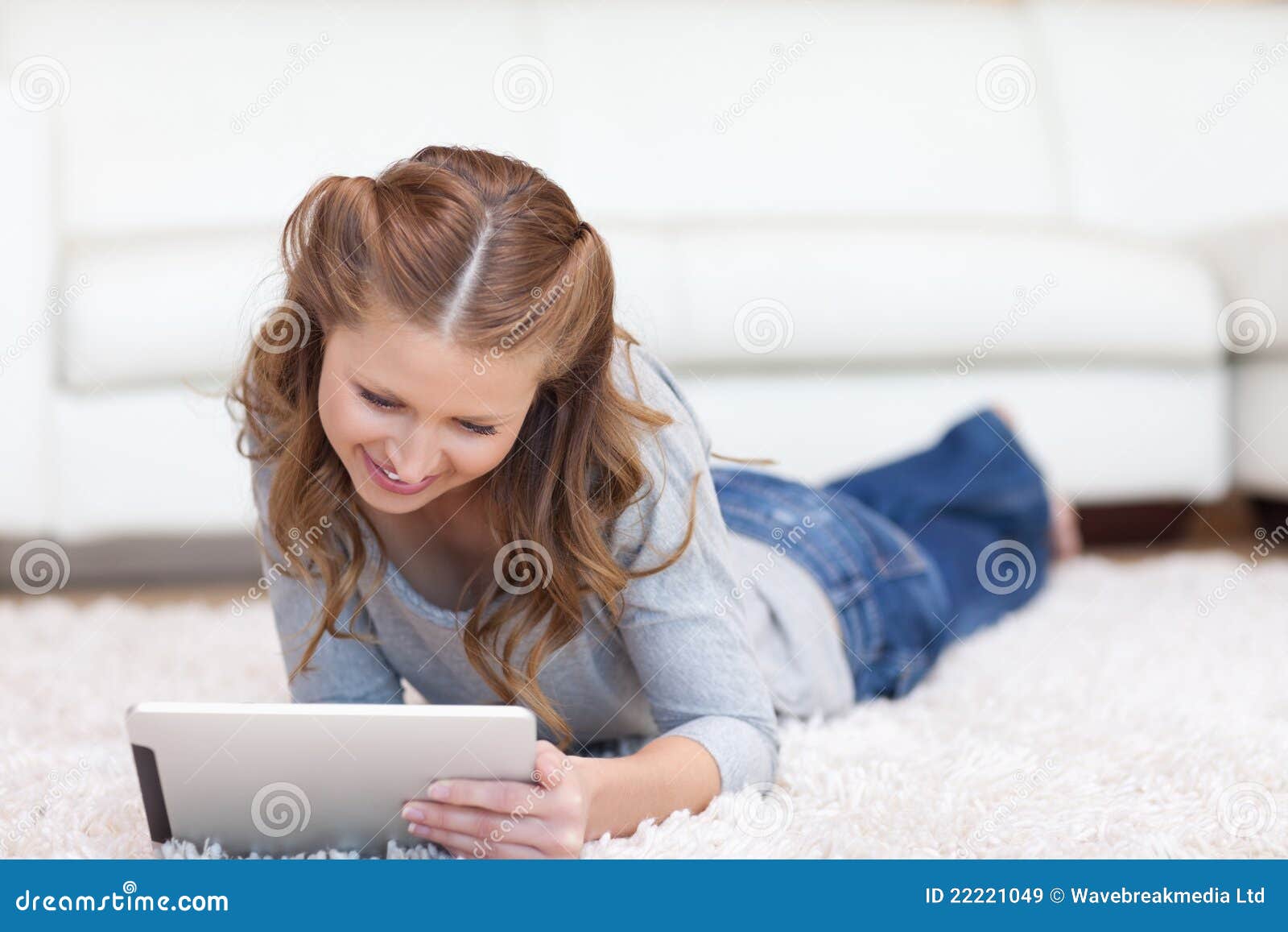 Woman Laying on the Carpet while Using Her Tablet Stock Image - Image ...