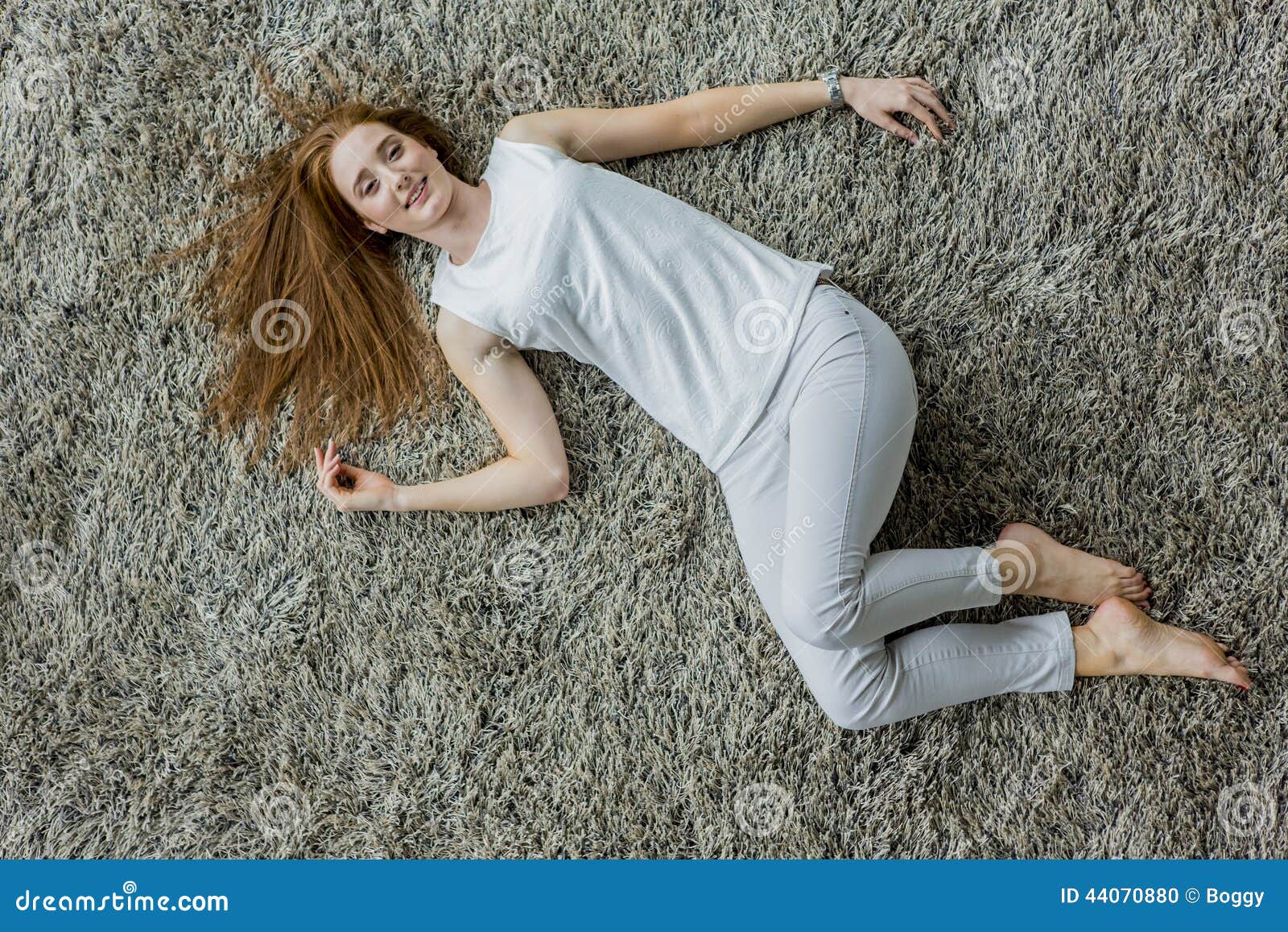 Woman laying on the carpet stock photo. Image of european - 44070880
