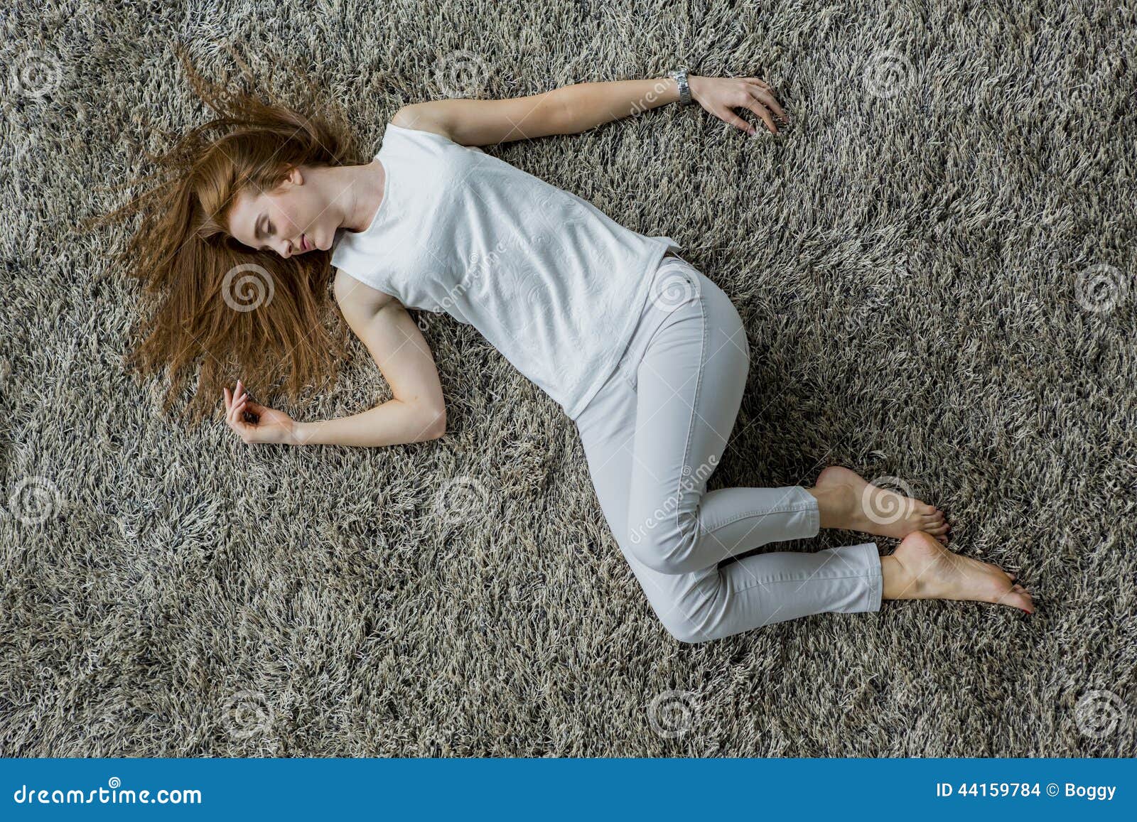 Woman laying on the carpet stock photo. Image of people - 44159784