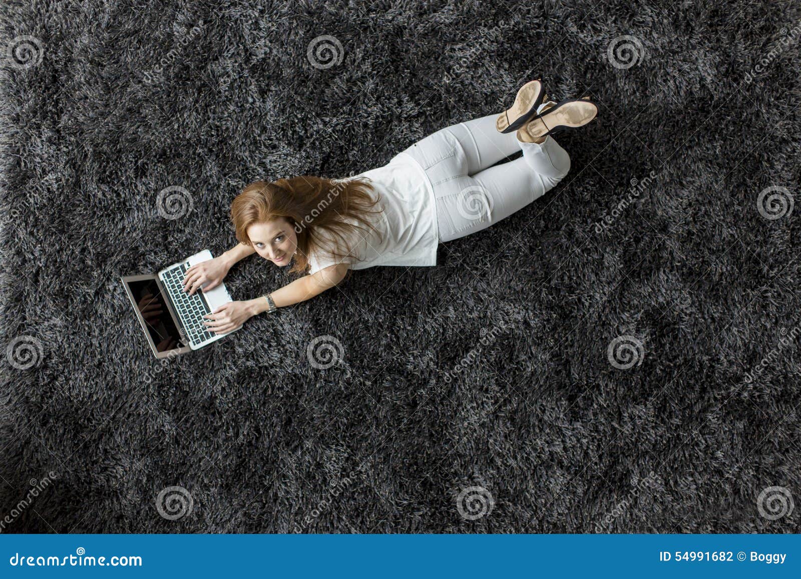 Woman laying on the carpet stock photo. Image of phone - 54991682