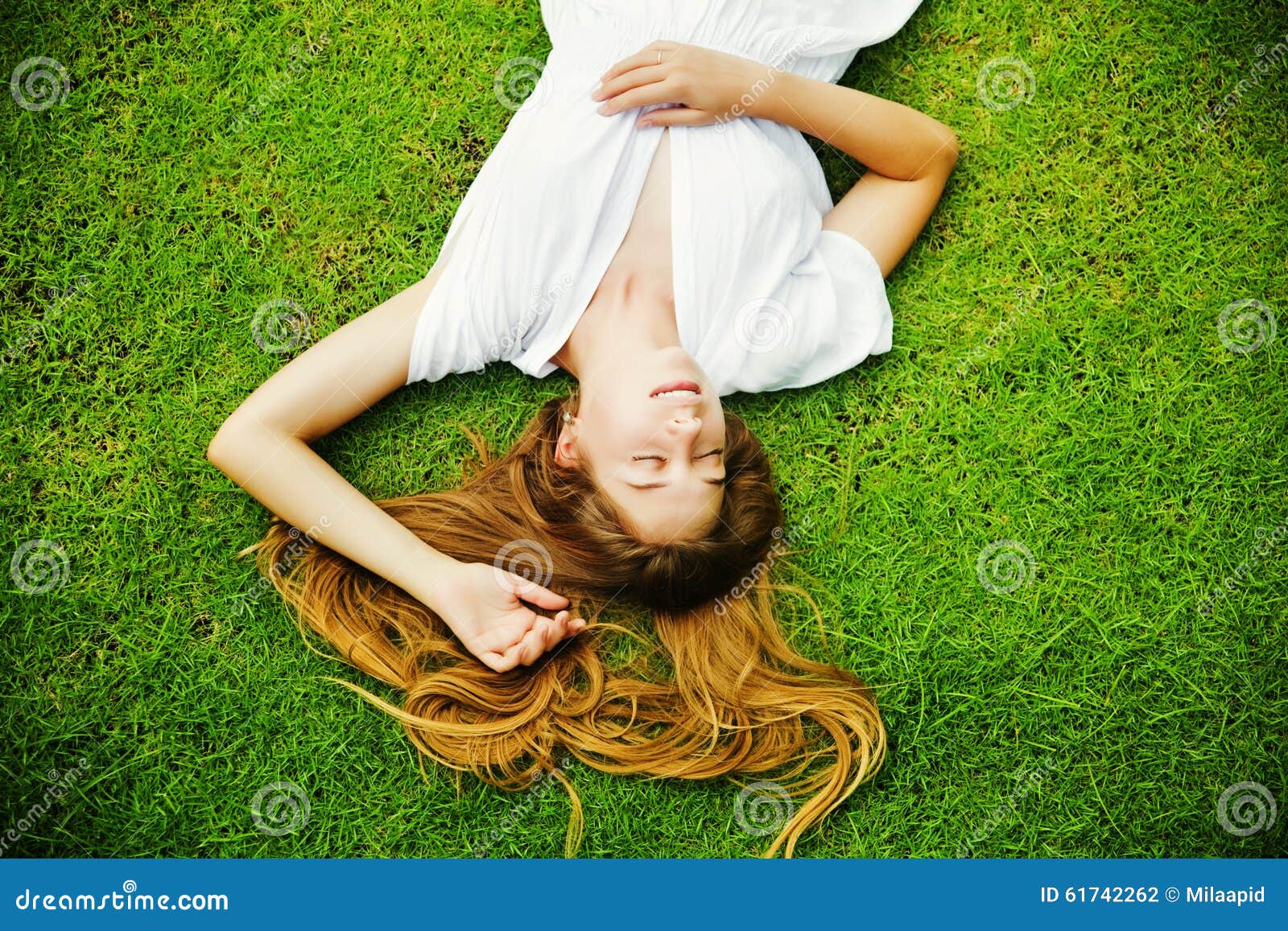 Woman laying on a grass stock photo. Image of cute, dress - 61742262