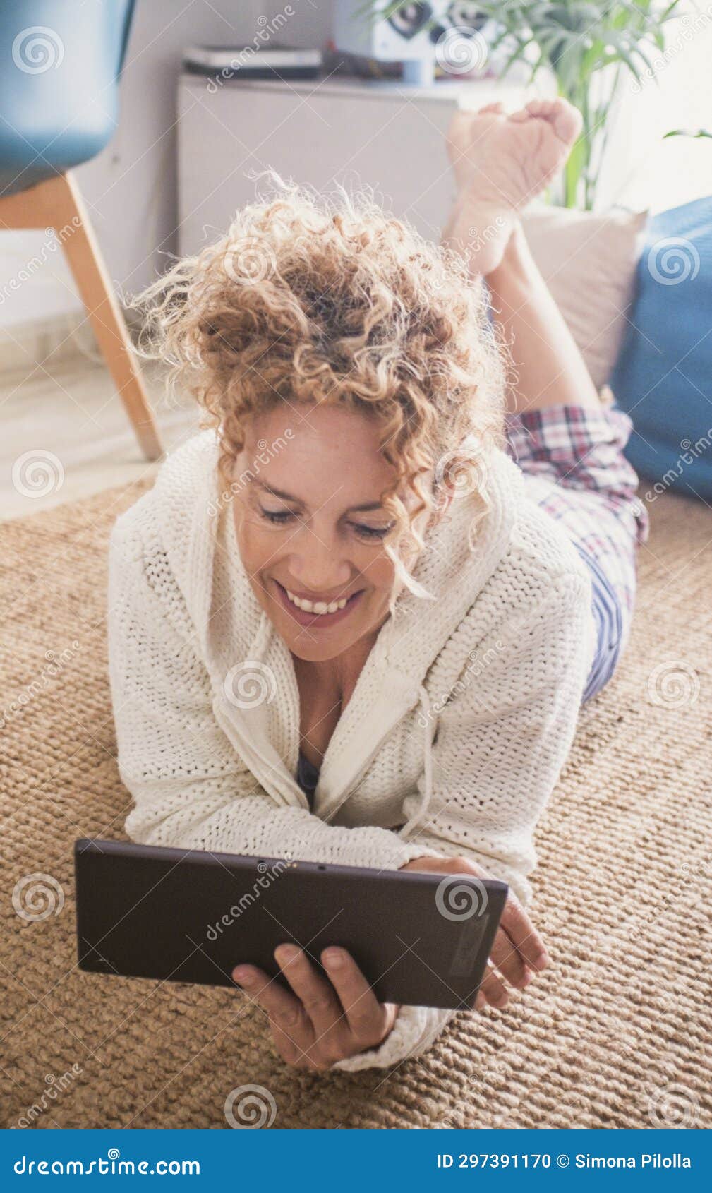 Woman Laying at Home on the Carpet Floor and Use Laptop Device with ... Woman Laying at Home on the Carpet Floor and Use Laptop Device with ...