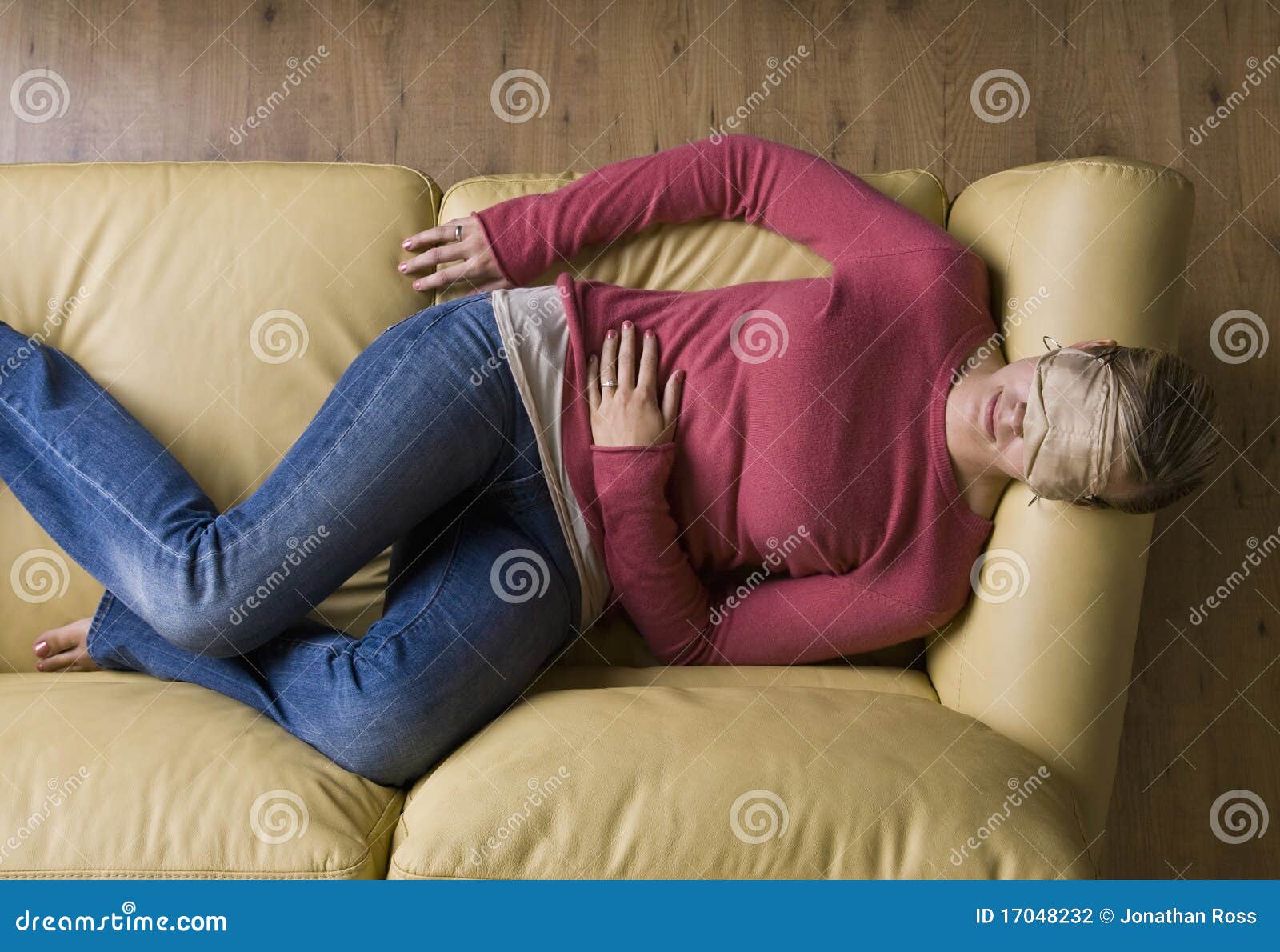 Woman Laying on Sofa Wearing Sleep Mask Stock Photo - Image of female ...