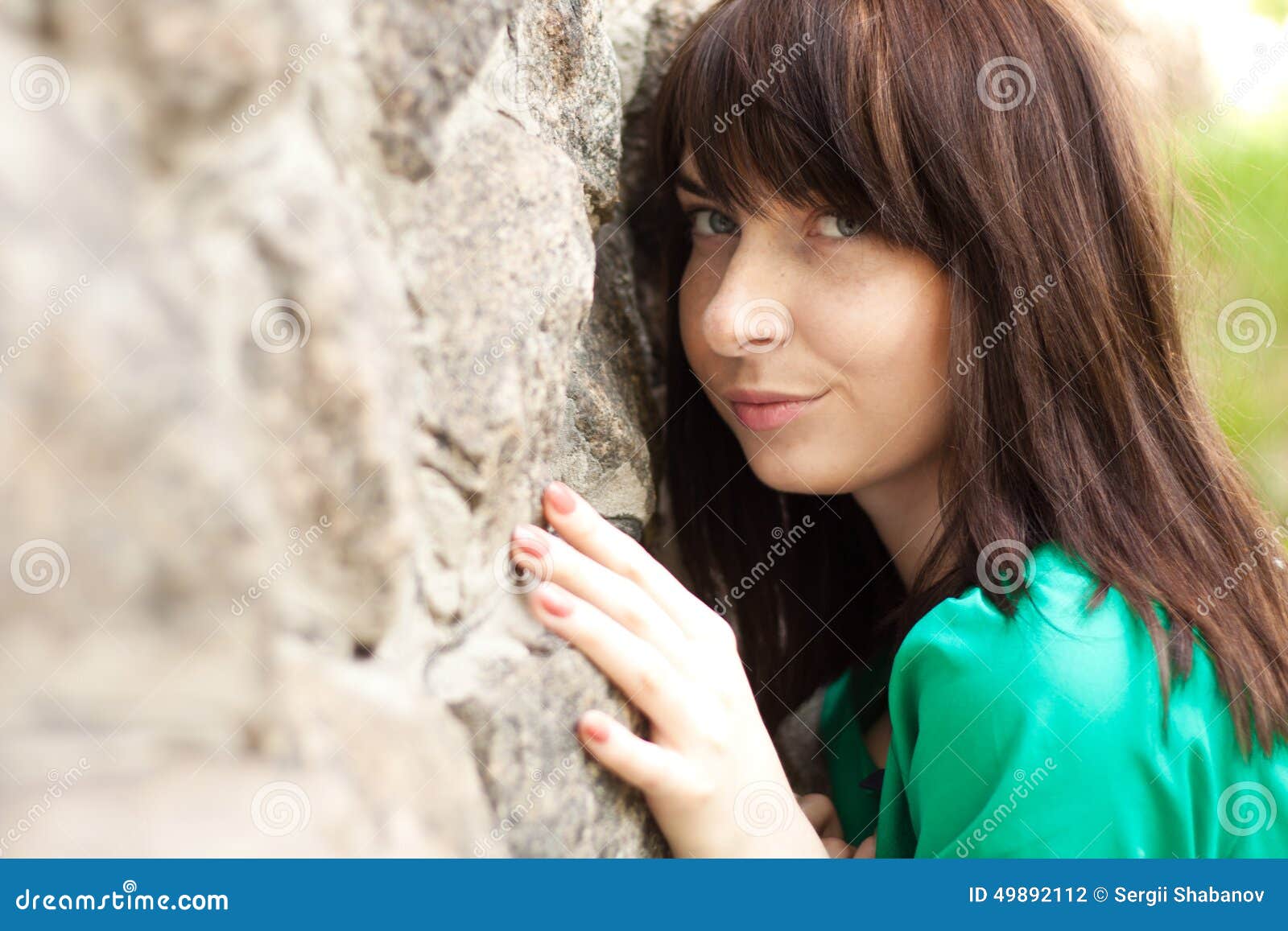 A Woman Leaning Against a Stone Wall Stock Photo - Image of fashion ...