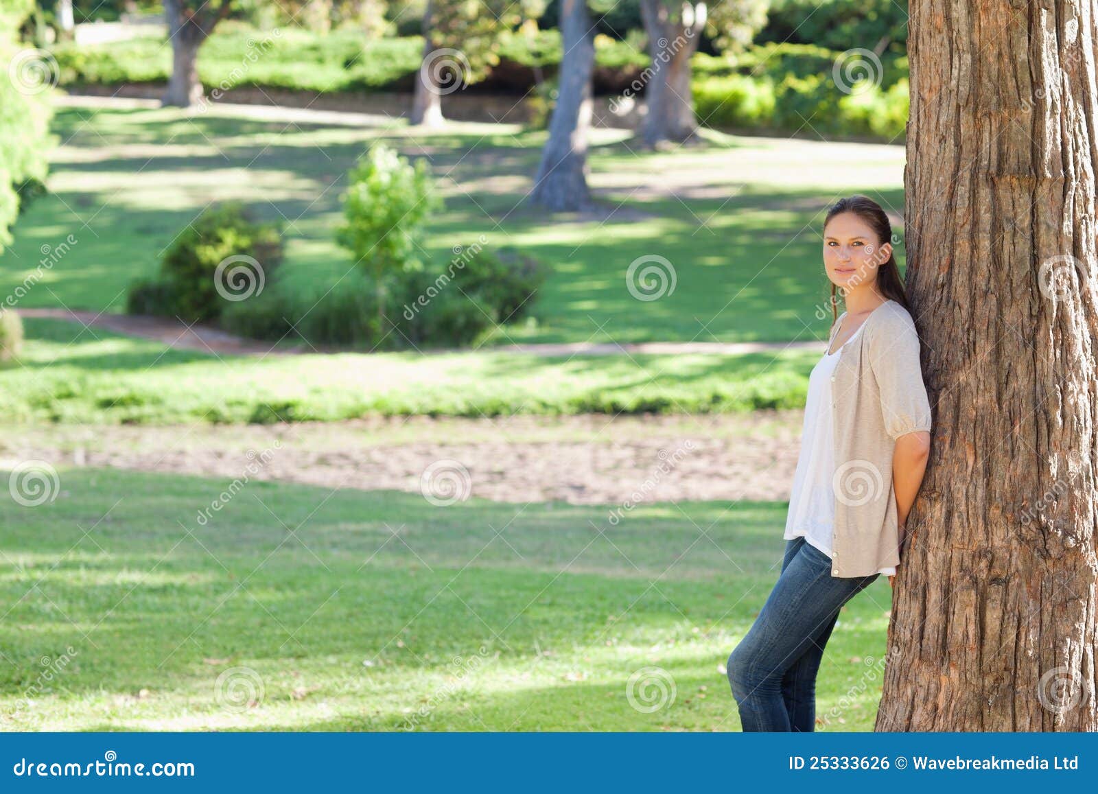 Woman Leaning Against a Tree in the Park Stock Photo - Image of leaves ...