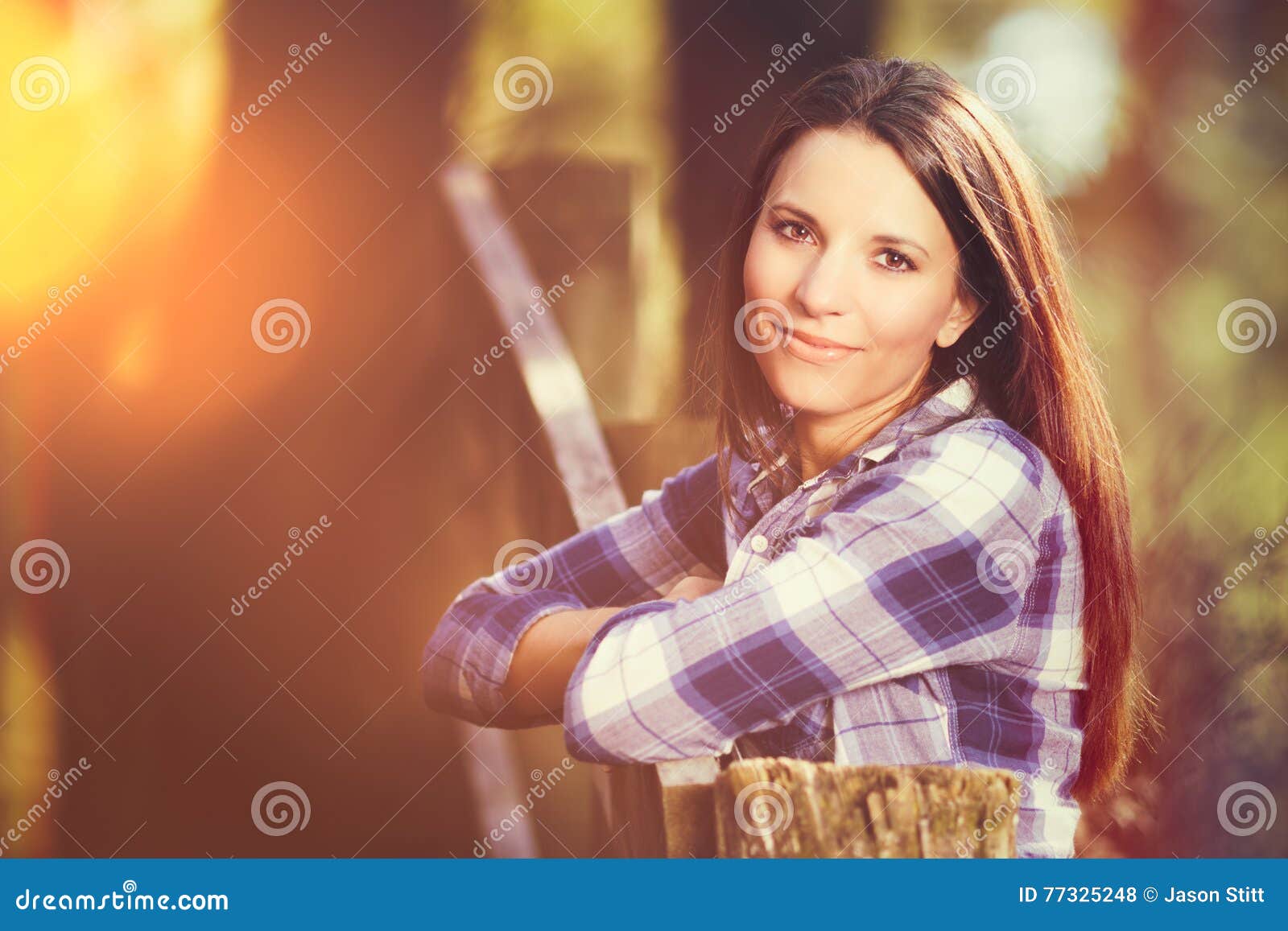 Woman Leaning on Fence stock photo. Image of golden, hour - 77325248