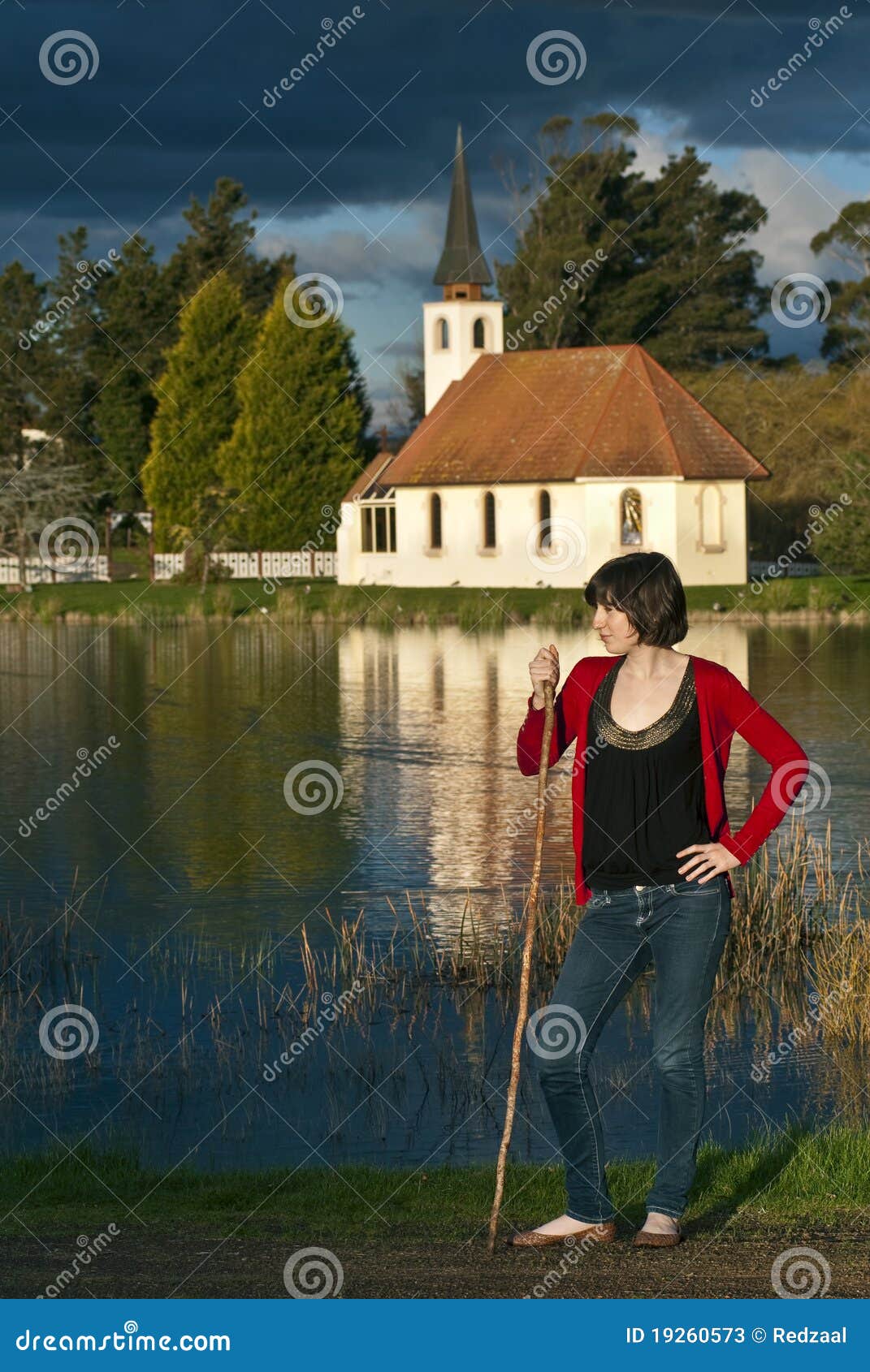 Woman Leaning on Stick by Church Stock Image - Image of light, jeans ...