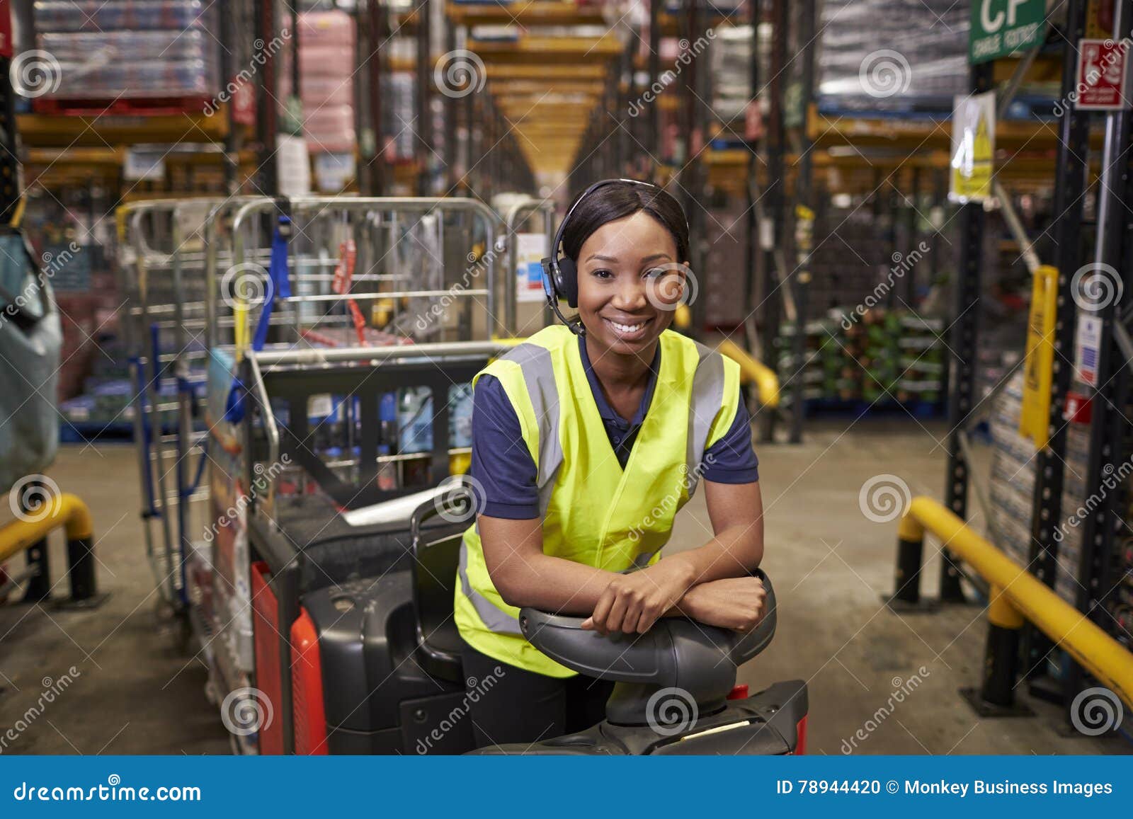 Woman Leaning on a Tow Tractor in a Distribution Warehouse Stock Photo ...