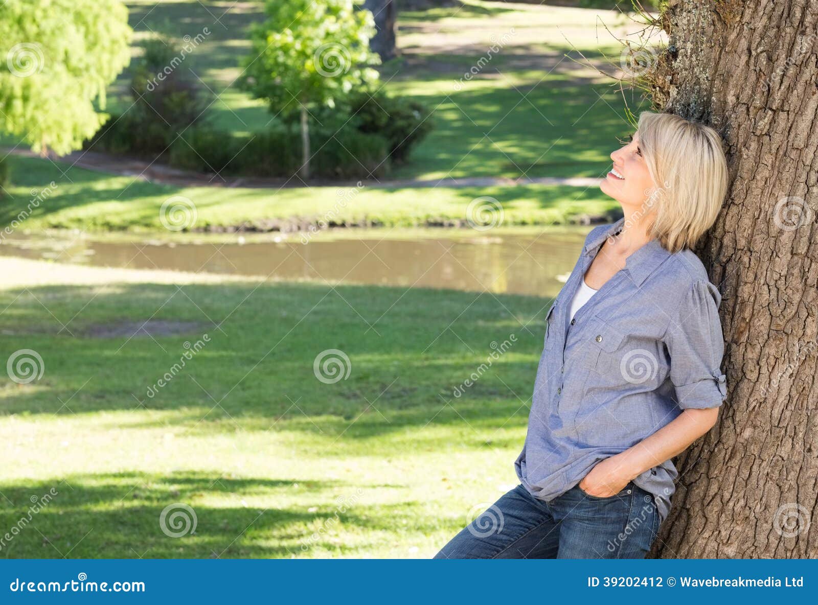 Woman Leaning on Tree Trunk in Park Stock Photo - Image of attractive ...
