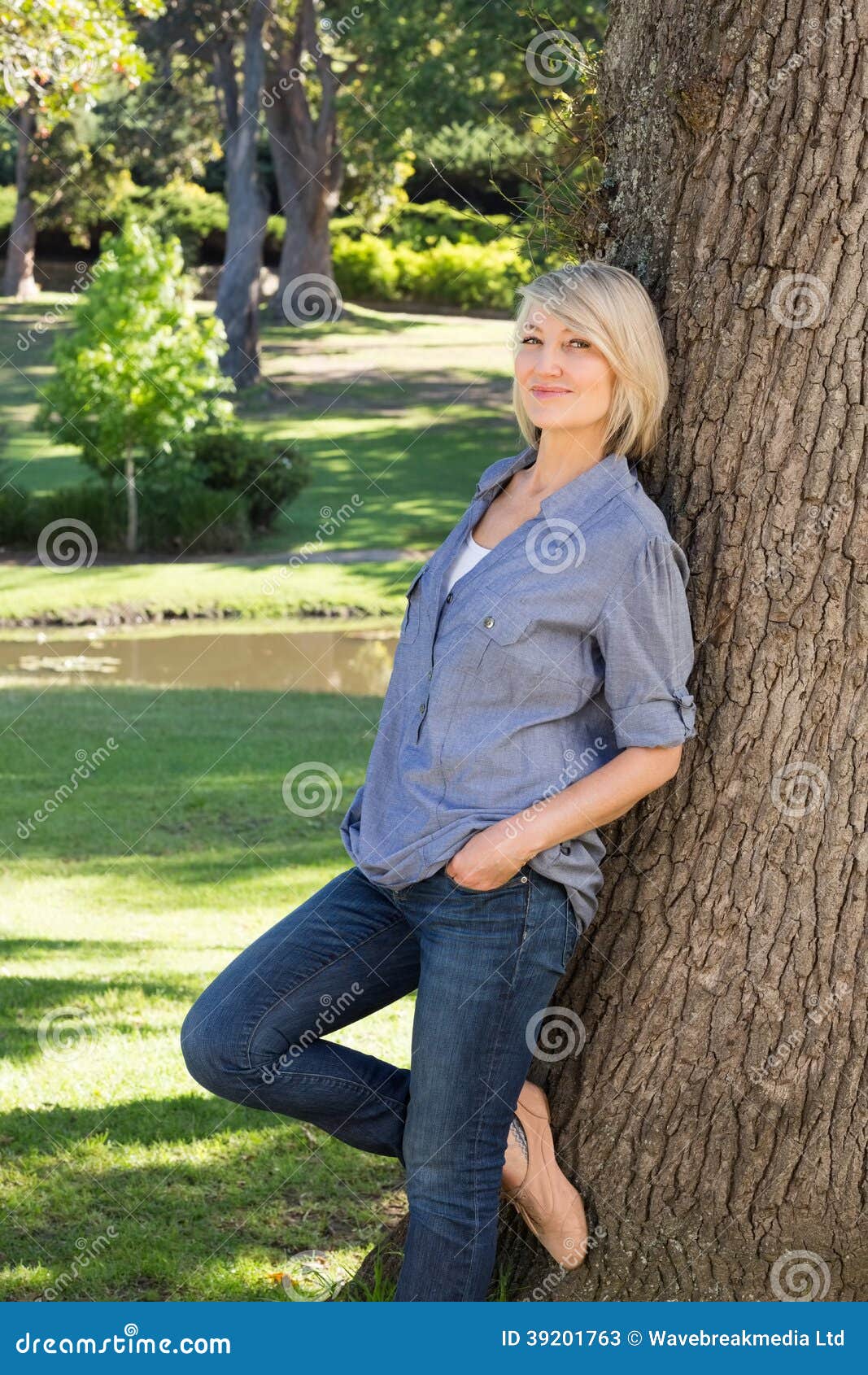 Woman Leaning on Tree Trunk in Park Stock Image - Image of tree, mature ...