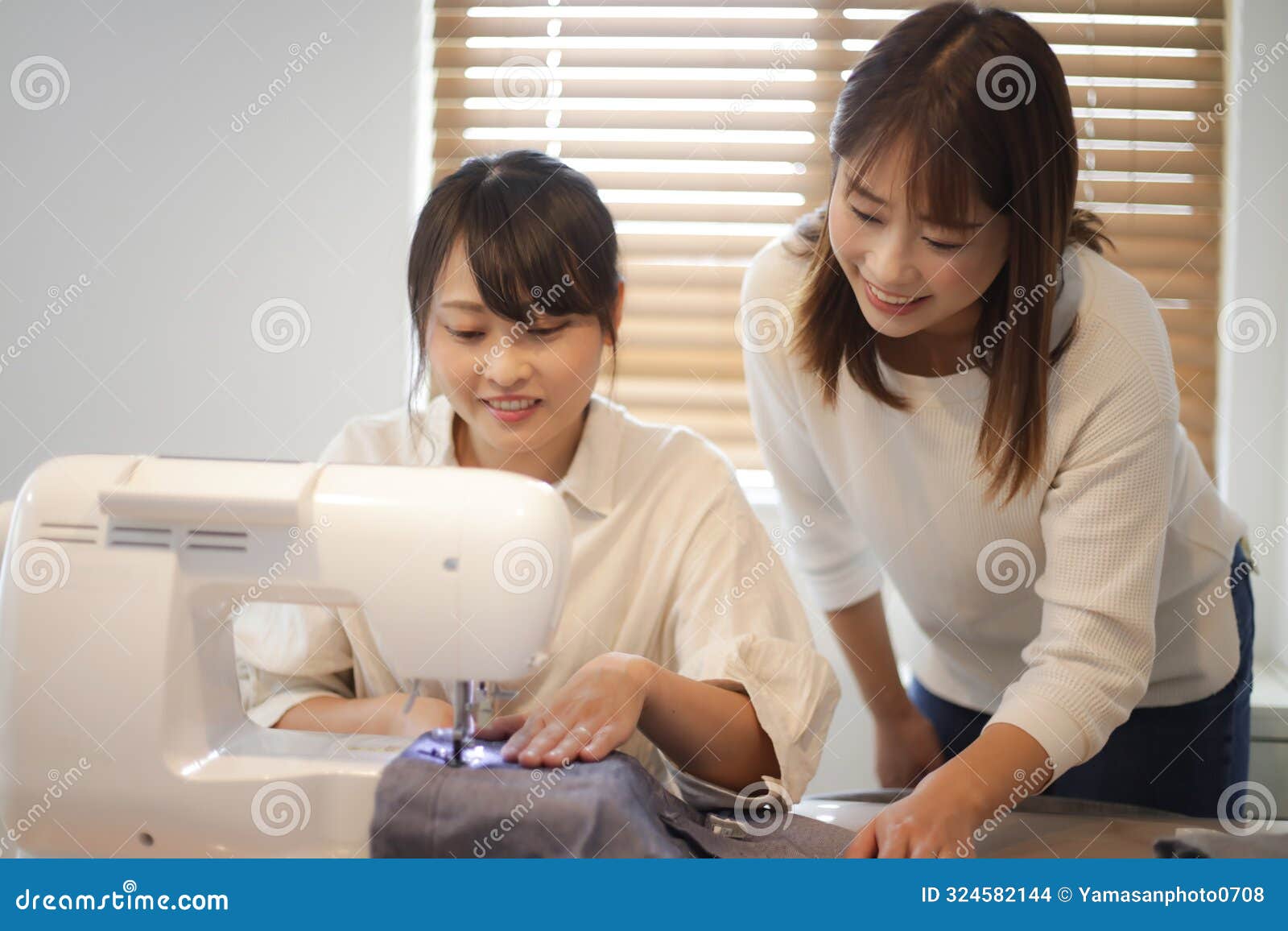 A Woman Learning How To Use a Sewing Machine Stock Photo - Image of ...