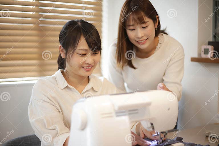 A Woman Learning How To Use a Sewing Machine Stock Image - Image of ...