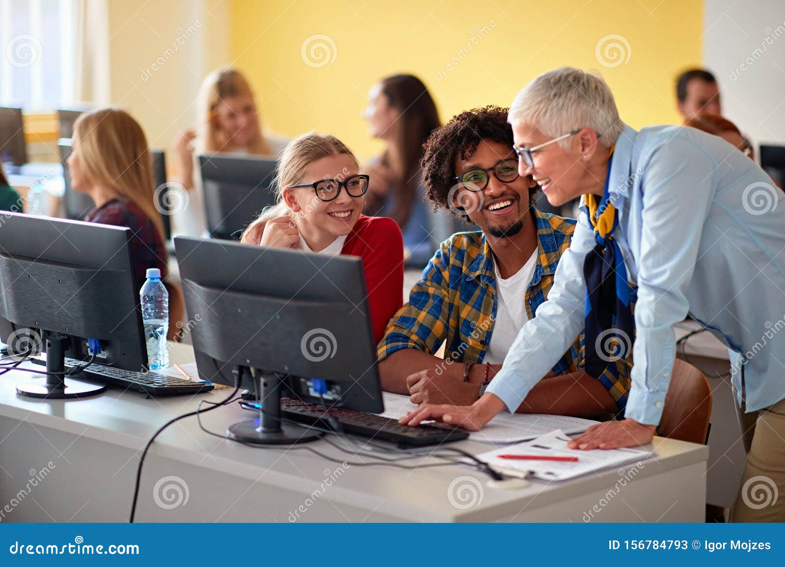 Woman Lecturer in Computer Class Assisting Group of Student Stock Image ...
