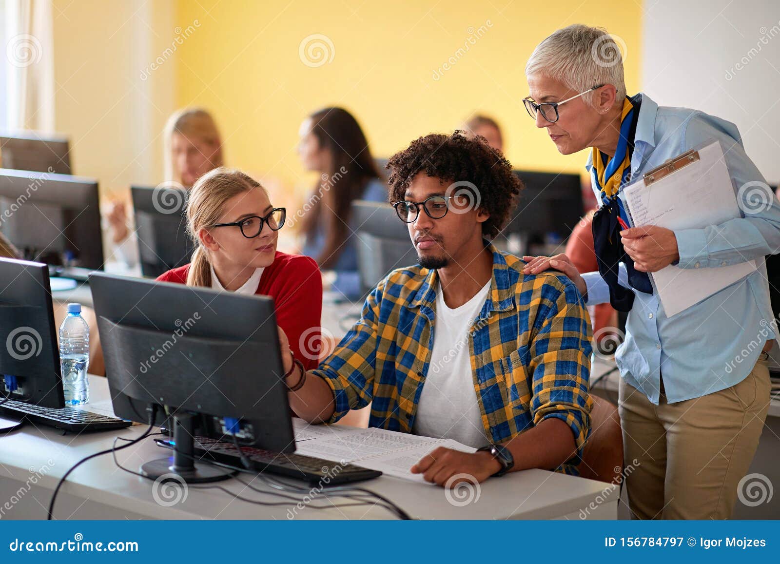 Woman Lecturer in Computer Class Assisting Student Stock Image - Image ...