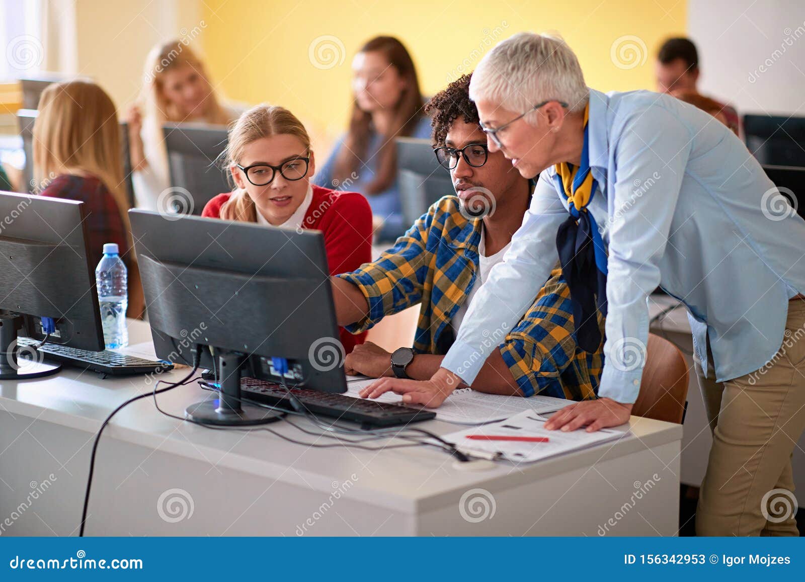 Woman Lecturer in Computer Class Assisting Student on University Stock ...