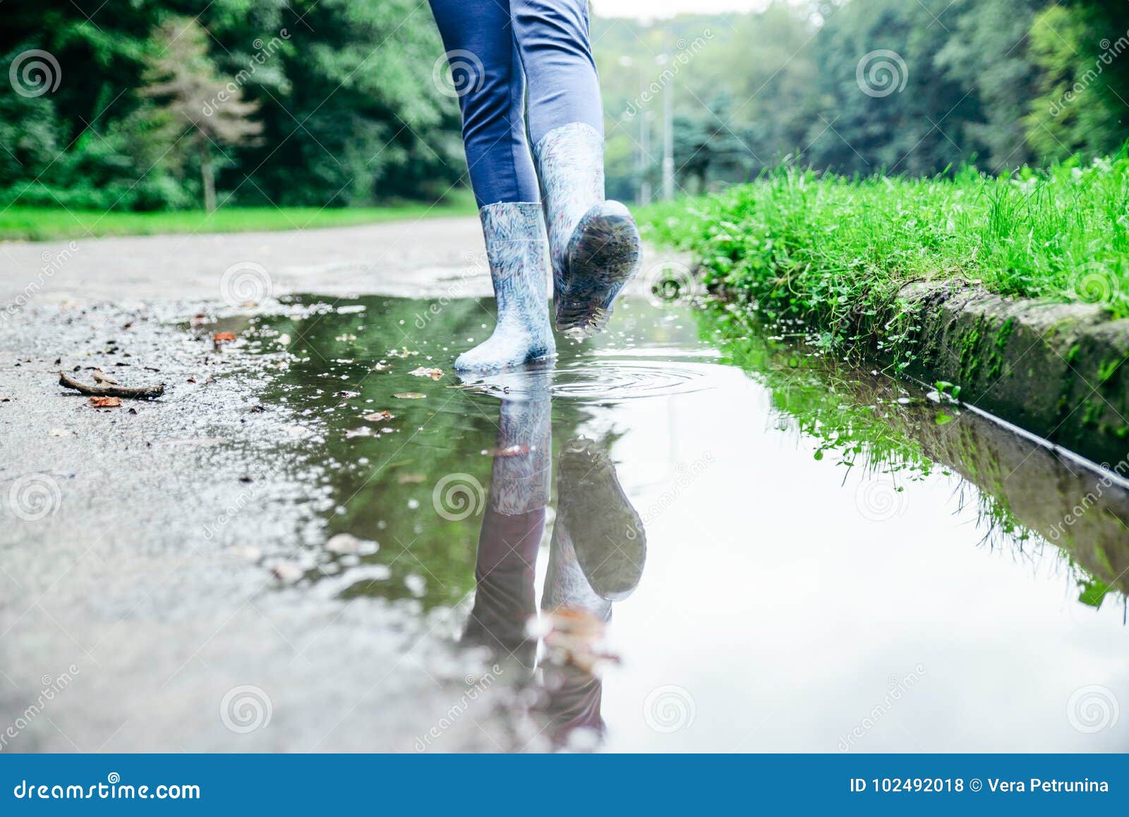 Woman Legs Walking by Puddle Stock Photo - Image of playful, protection ...