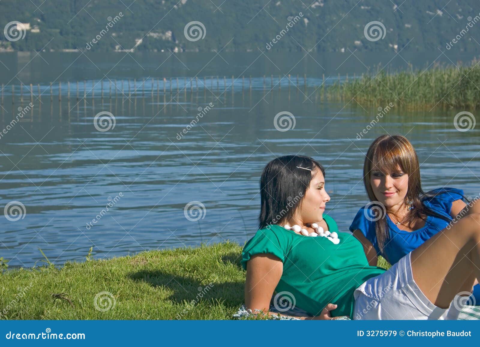 Woman Lengthened in the Grass Stock Image - Image of nature, friendship ...