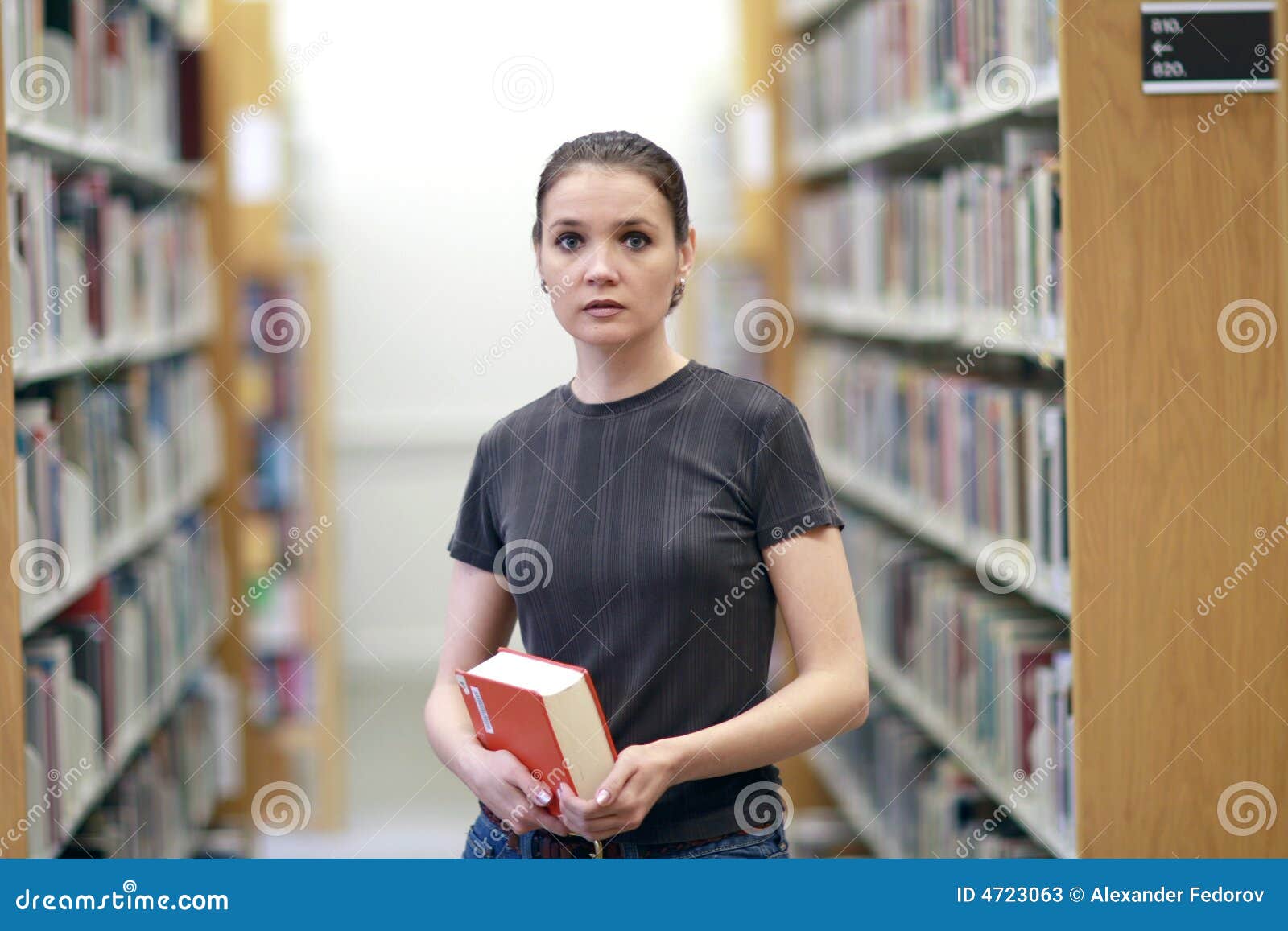 Woman in the library stock image. Image of college, bookshelf - 4723063