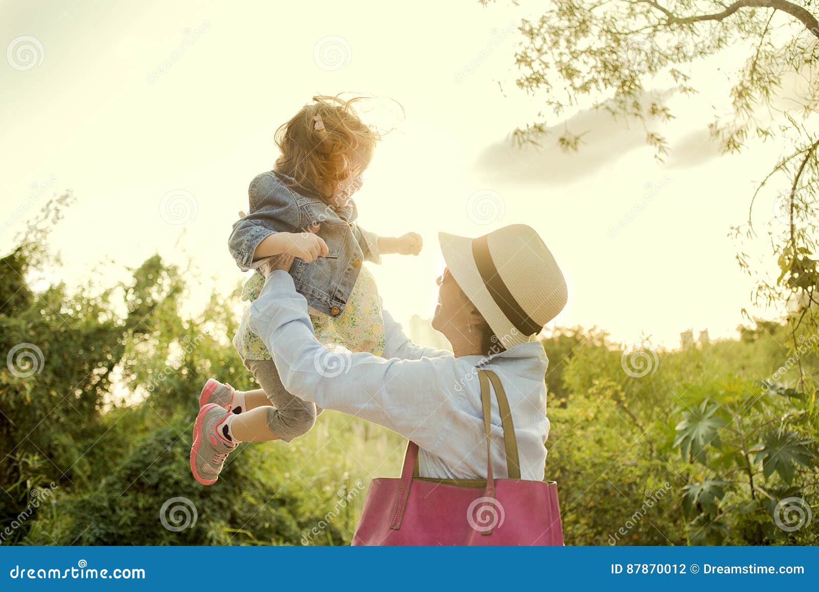 Woman lifting Child up. stock photo. Image of caucasian - 87870012