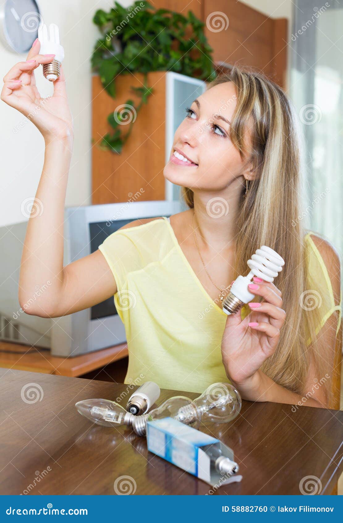 Woman with Light Bulbs at Home Stock Photo - Image of armful, happy ...