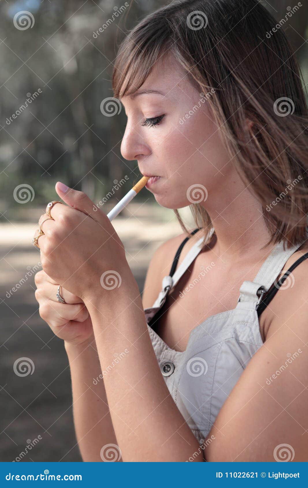 Woman lighting a cigarette stock image. Image of beauty - 11022621