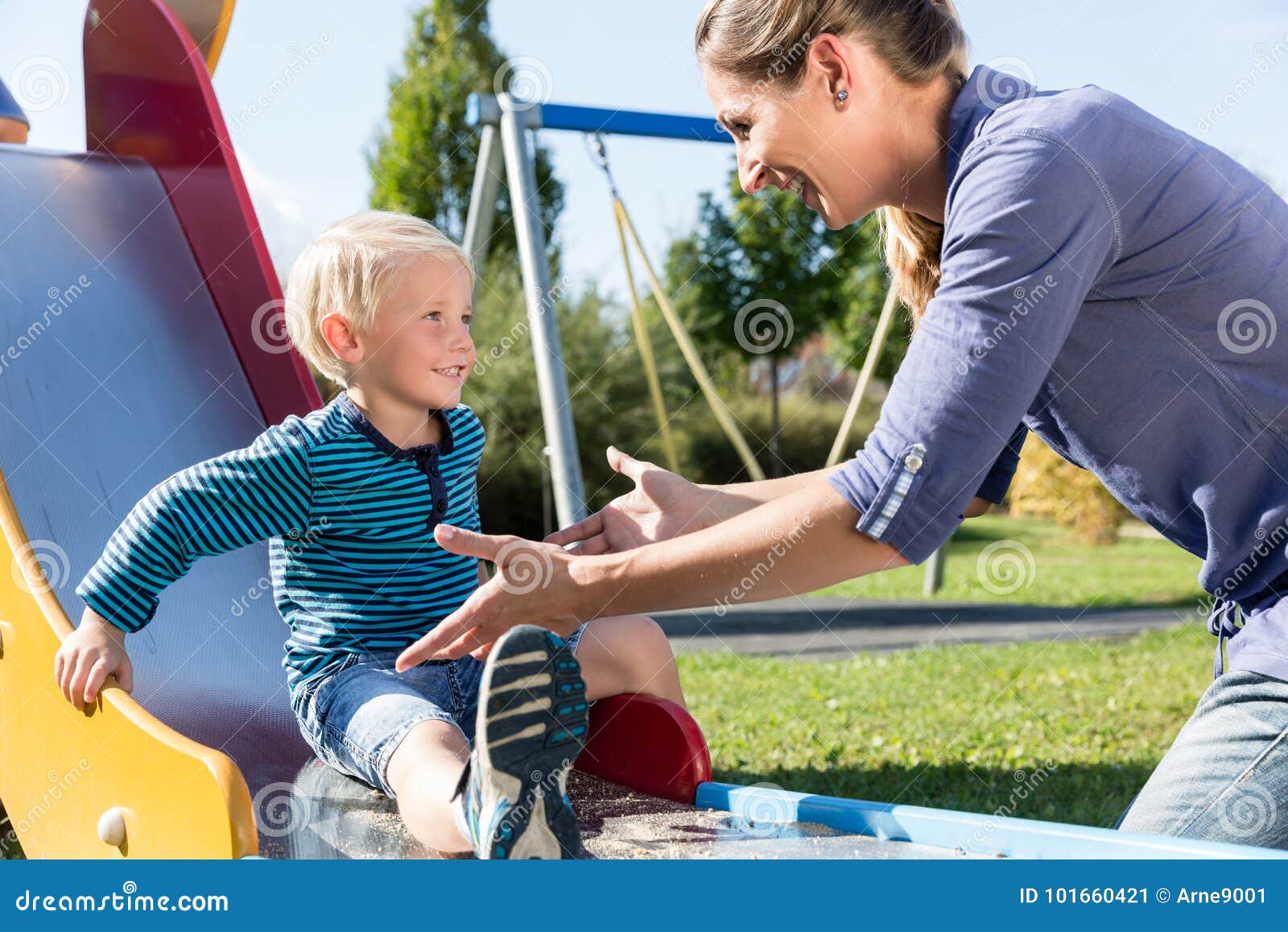 Woman and Little Boy Chuting Down Slide at Playground Stock Image ...