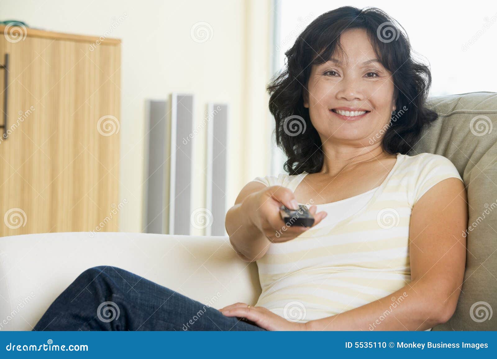 Woman in Living Room Holding Remote Control Stock Photo - Image of ...