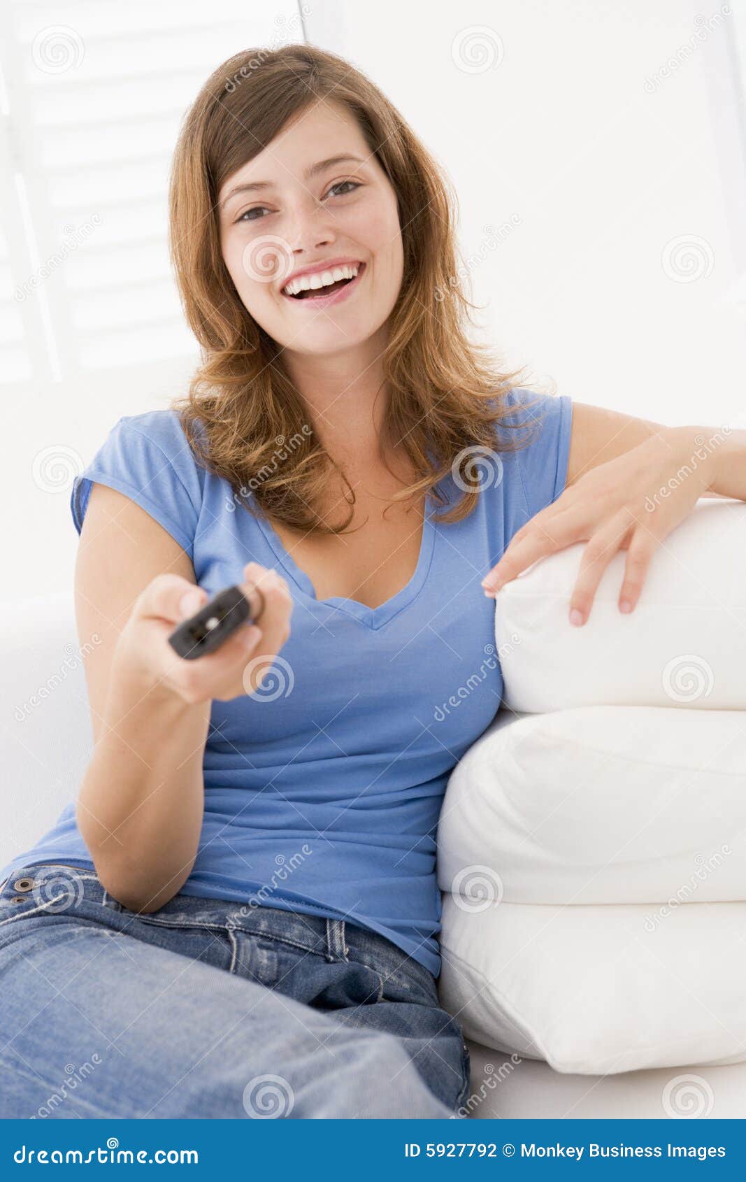 Woman in Living Room with Remote Control Stock Photo - Image of ...