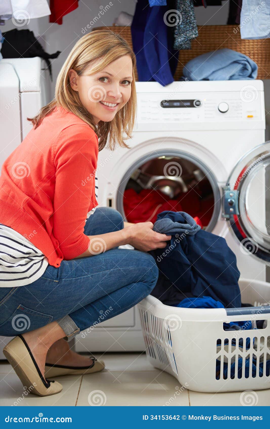 Woman Loading Clothes into Washing Machine Stock Photo - Image of ...
