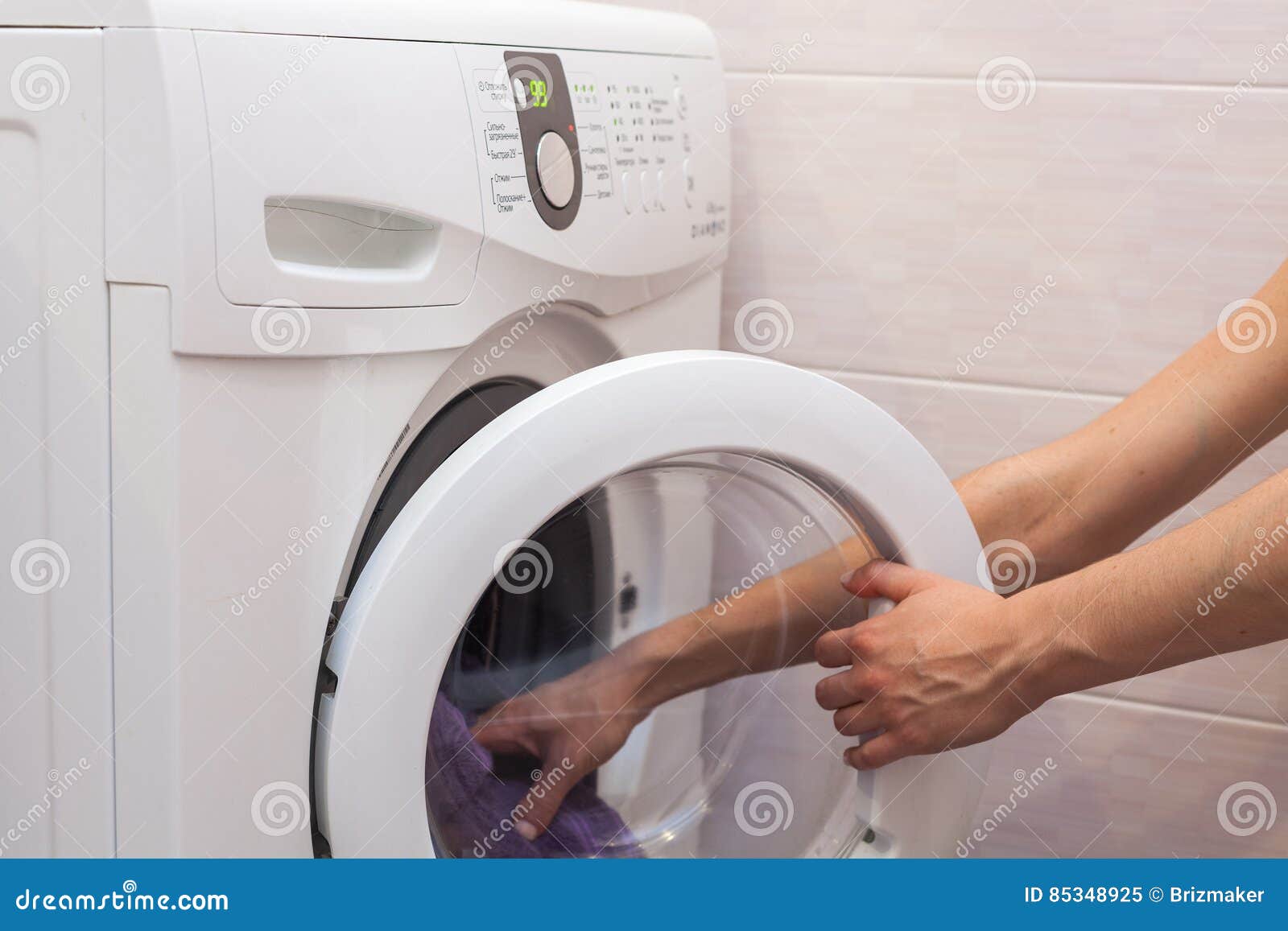 Woman Loading Laundry To the Washing Machine. Stock Image - Image of ...