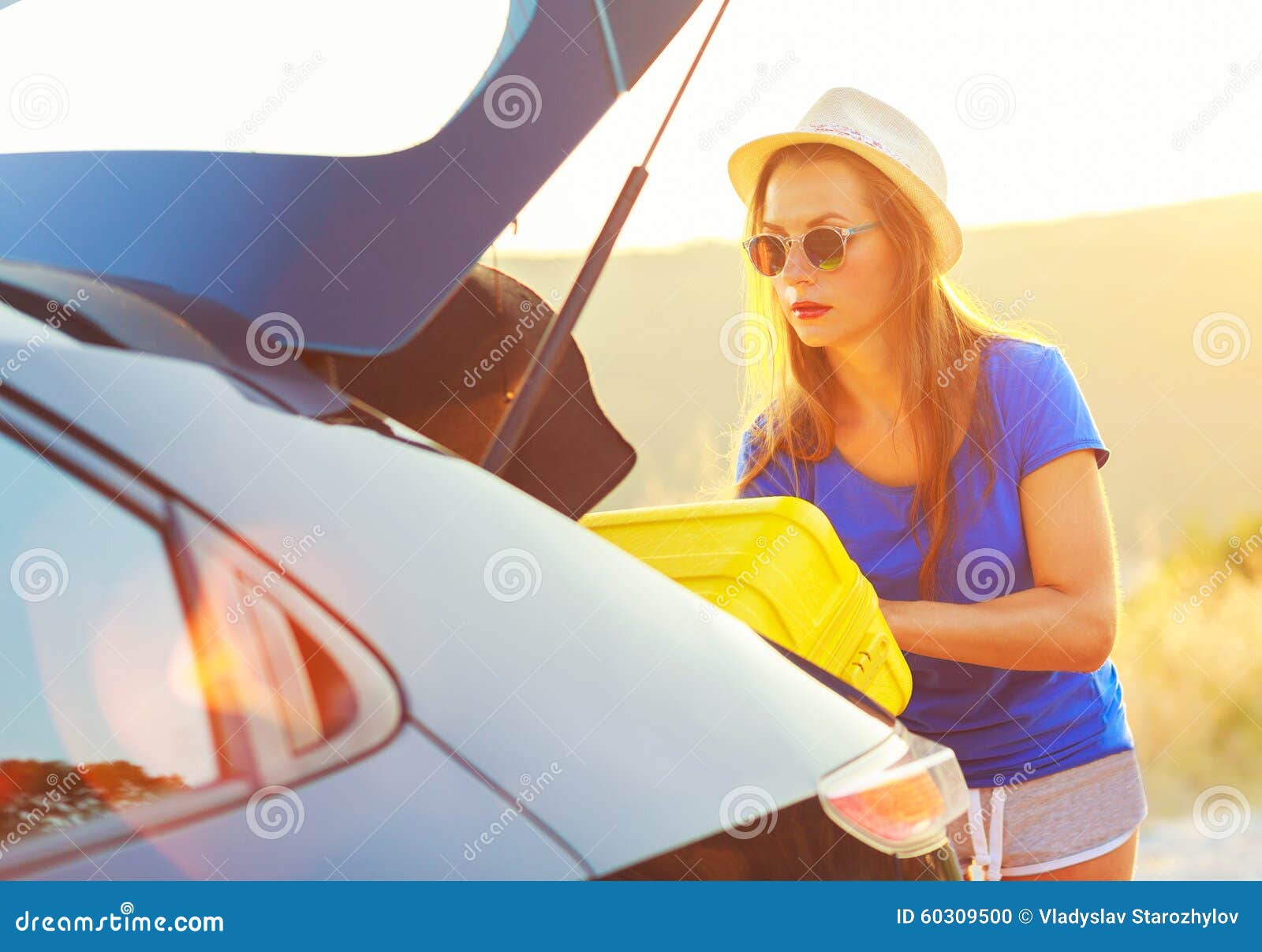 Woman Loading Luggage into the Back of Car Parked Alongside the Stock ...