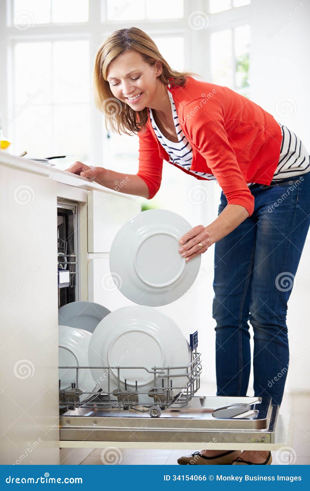 Woman Loading Plates into Dishwasher Stock Photo - Image of loading ...