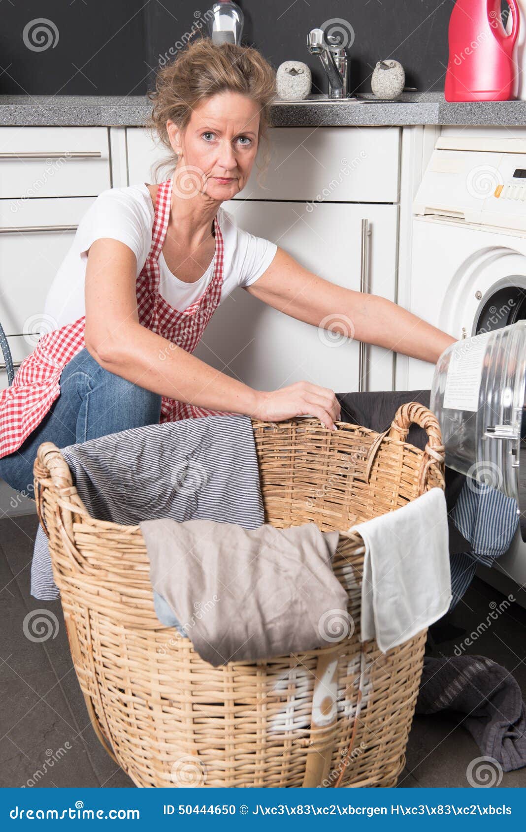 Woman Loading Washing Machine Stock Photo - Image of face, ager: 50444650