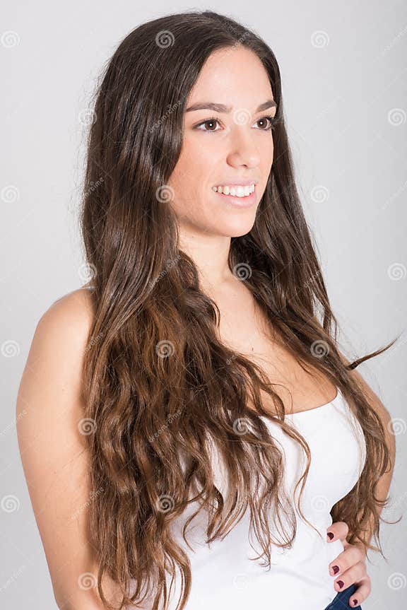 Woman With Long Hair Wearing White T Shirt And Blue Jeans Stock Image