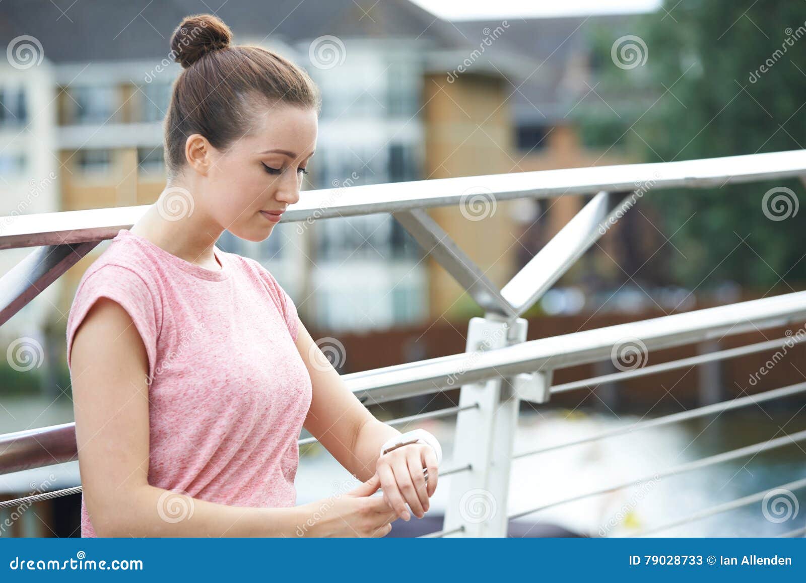 Woman Looking at Activity Tracker Whilst Exercising in City Stock Image ...