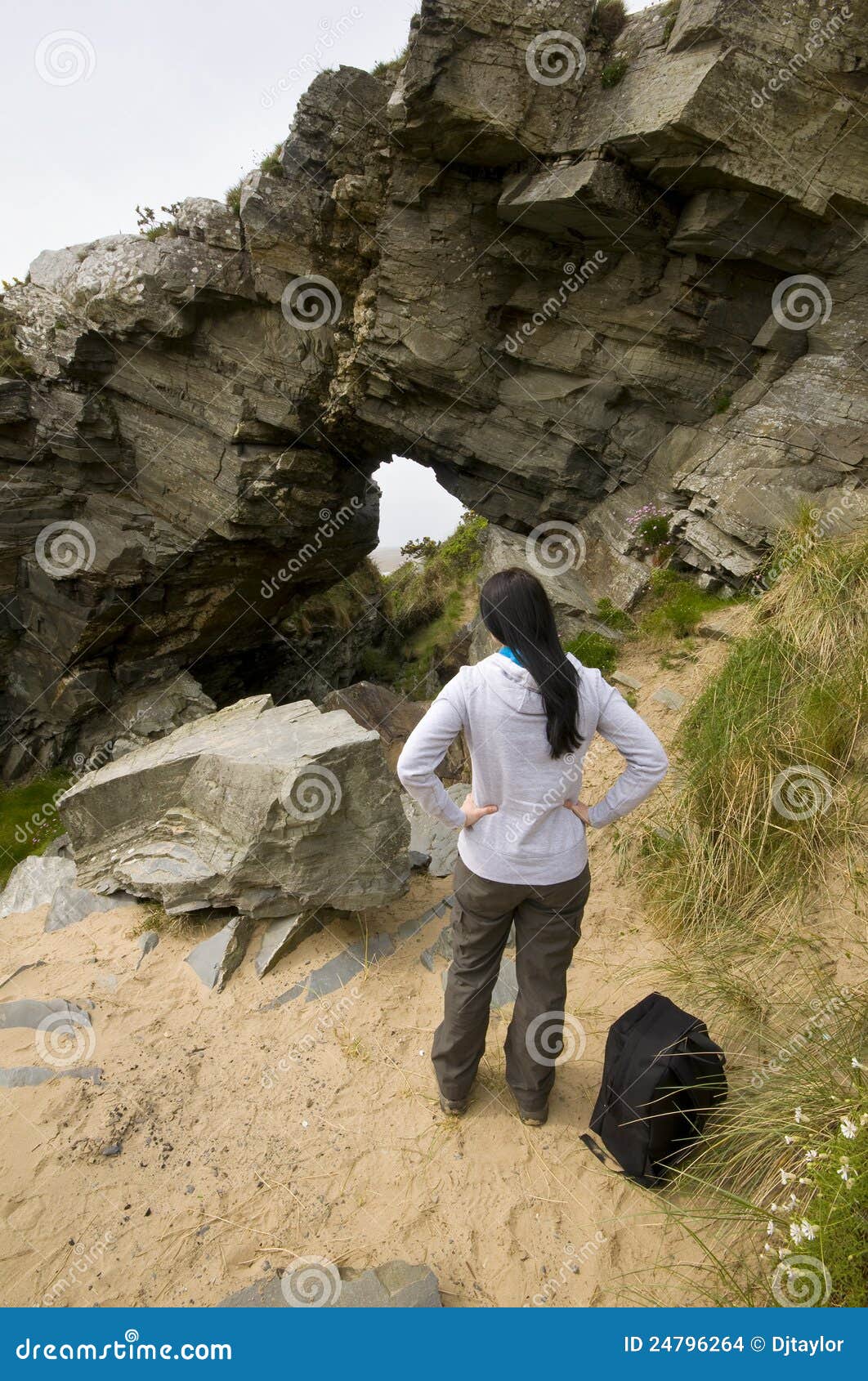 Woman Looking through Arch Made from Rock Stock Photo - Image of rock ...