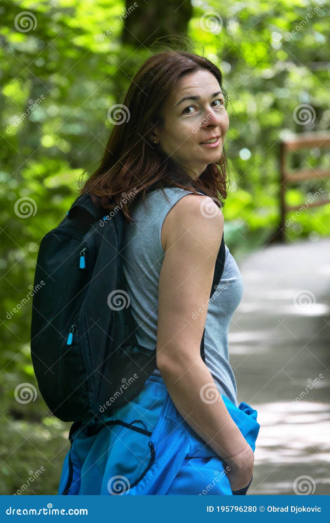 Woman Looking Back while Walking through the Forest. Stock Photo ...