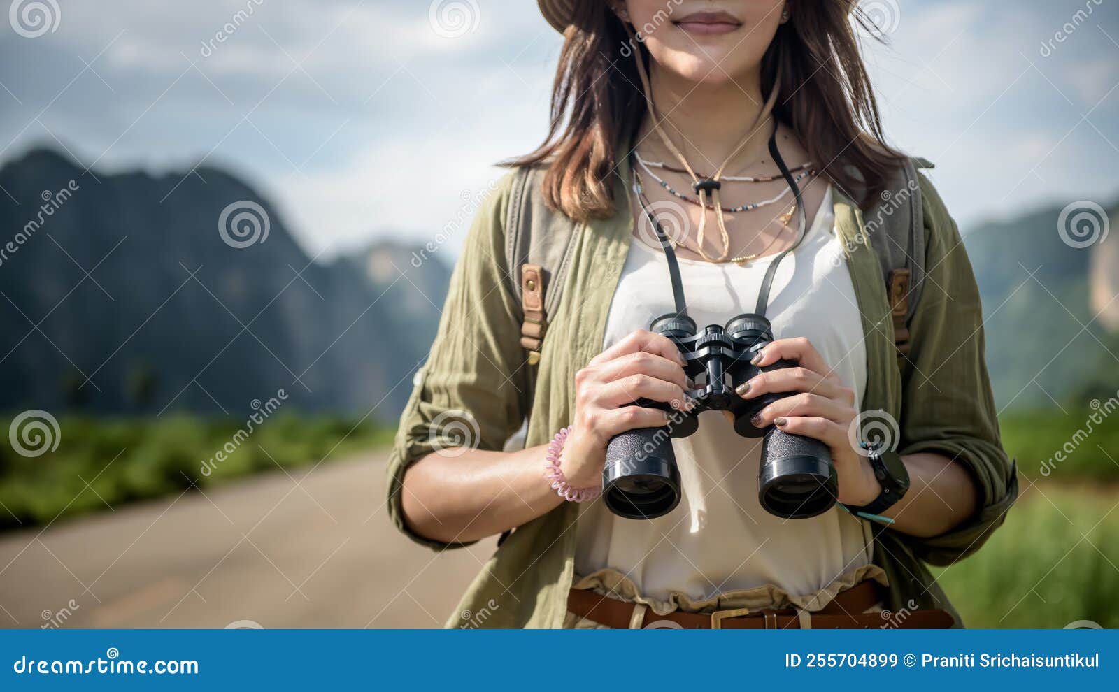Woman Looking through Binoculars on the Hill Woman in T-shirt with ...