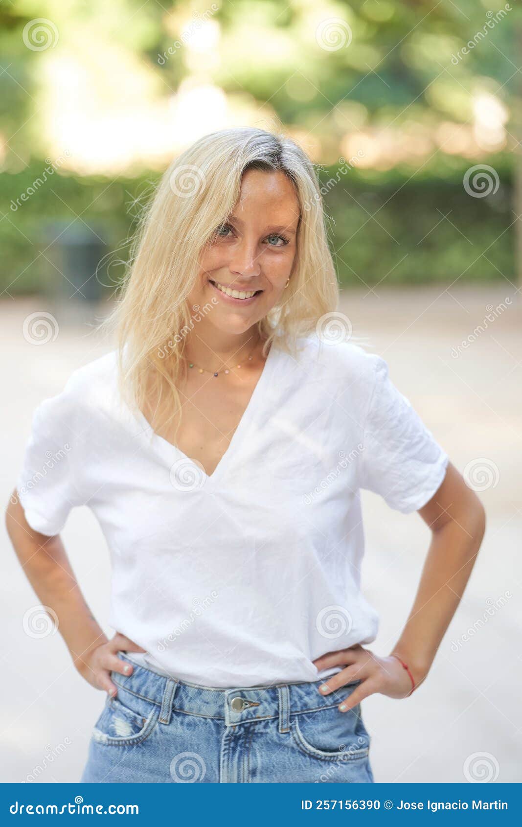 Woman Looking at the Camera and Smiling while Standing with Her Hands ...