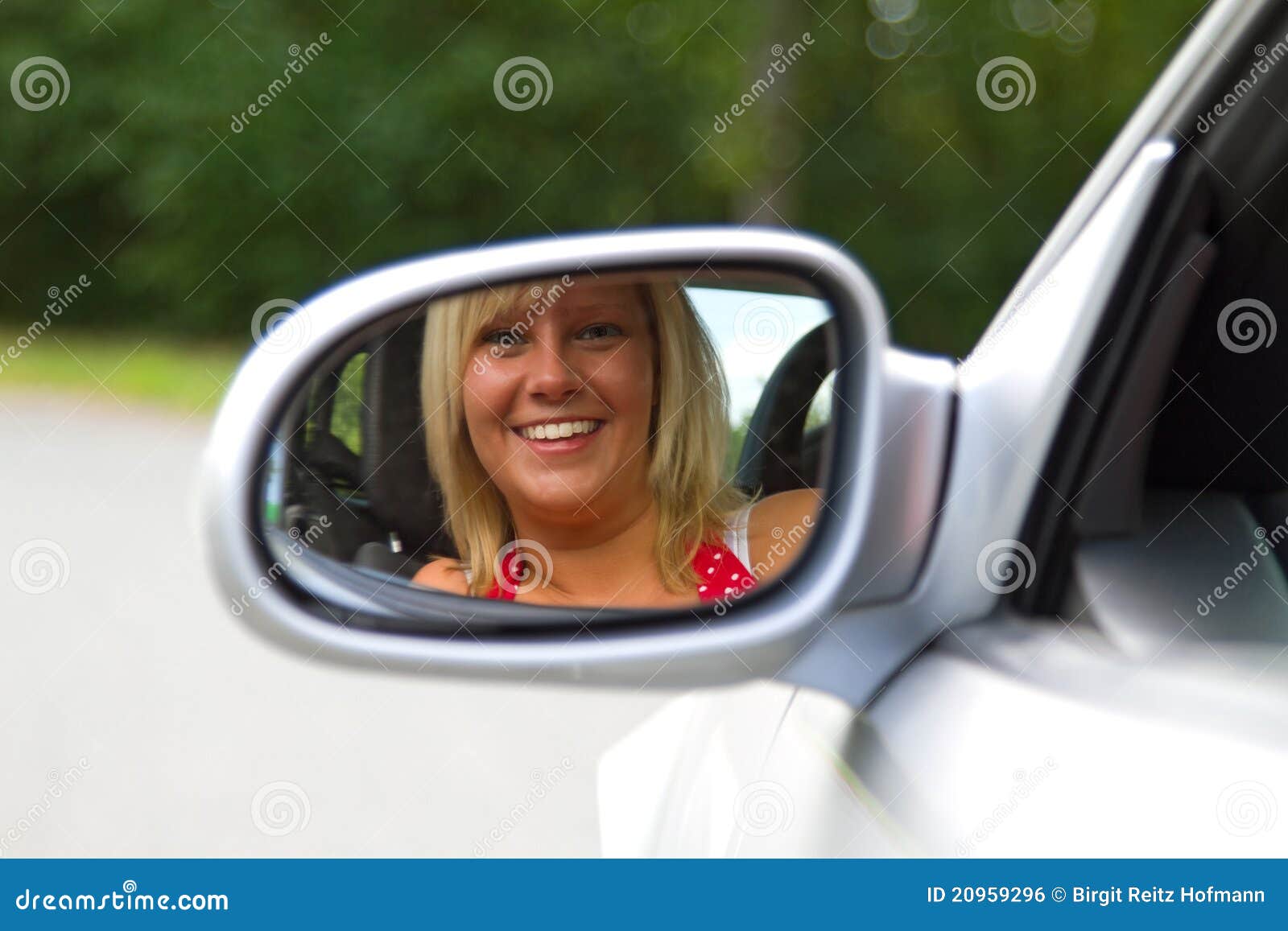 Woman Looking in a Car Mirror Stock Photo - Image of young, happy: 20959296