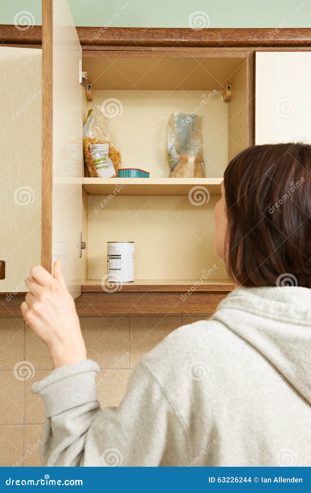 Woman Looking in Empty Food Cupboards Stock Photo - Image of shelf ...