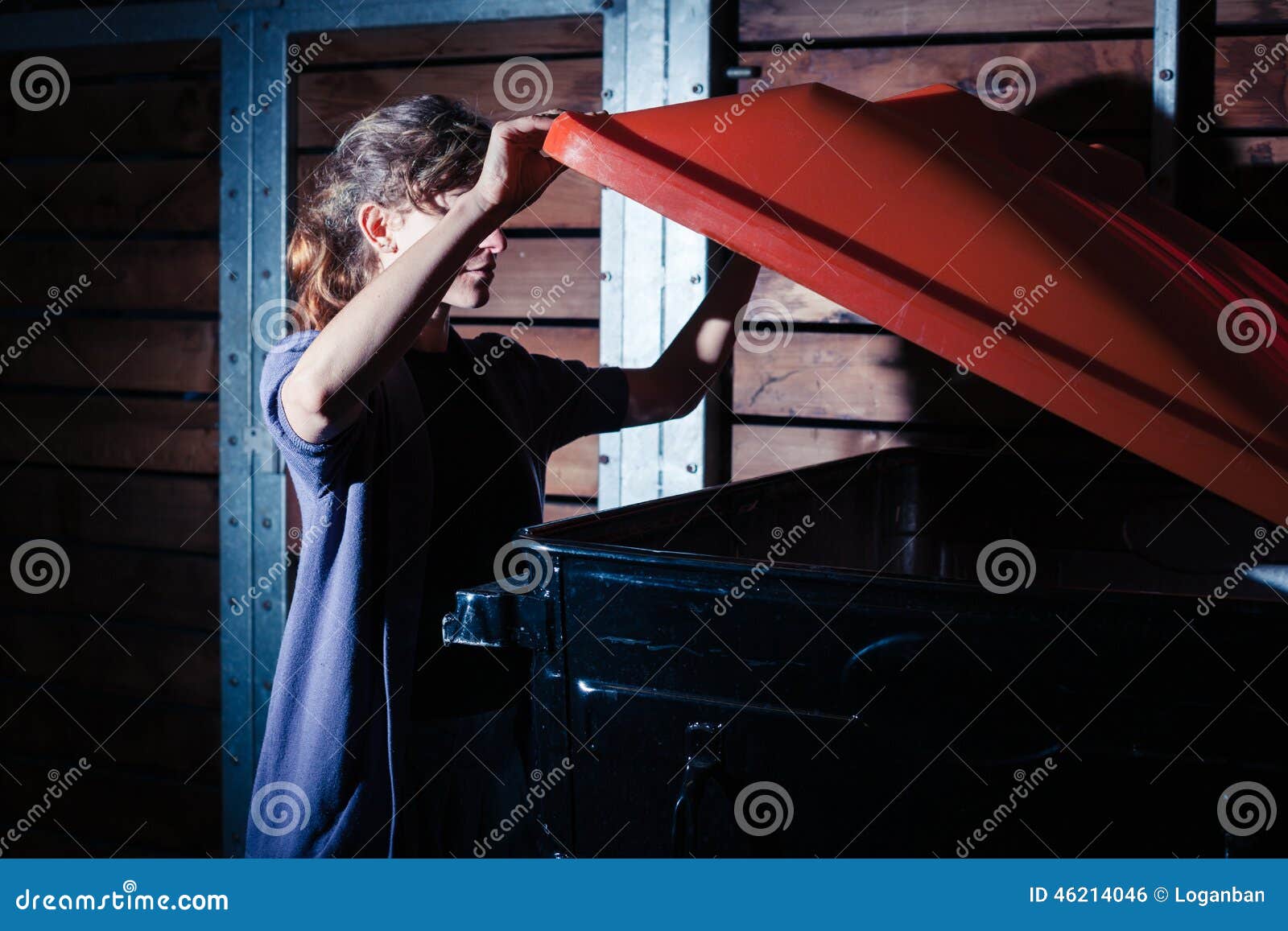 Woman looking inside a bin stock photo. Image of trash - 46214046