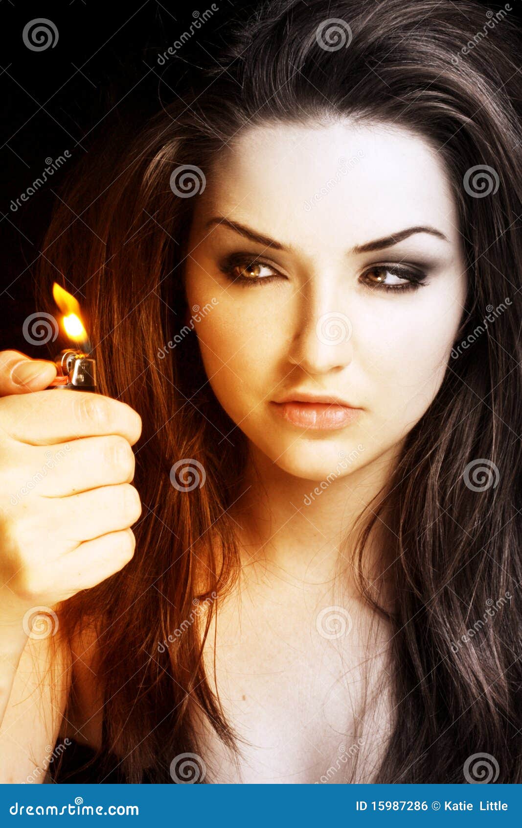 Woman looking at a lighter stock photo. Image of beautiful - 15987286