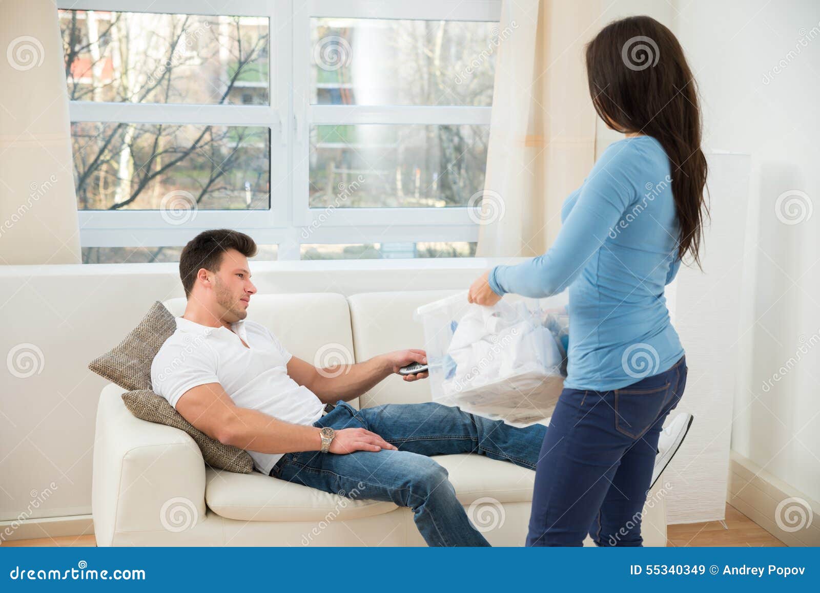 Woman Looking at Man Using Remote Control Stock Image - Image of duty ...