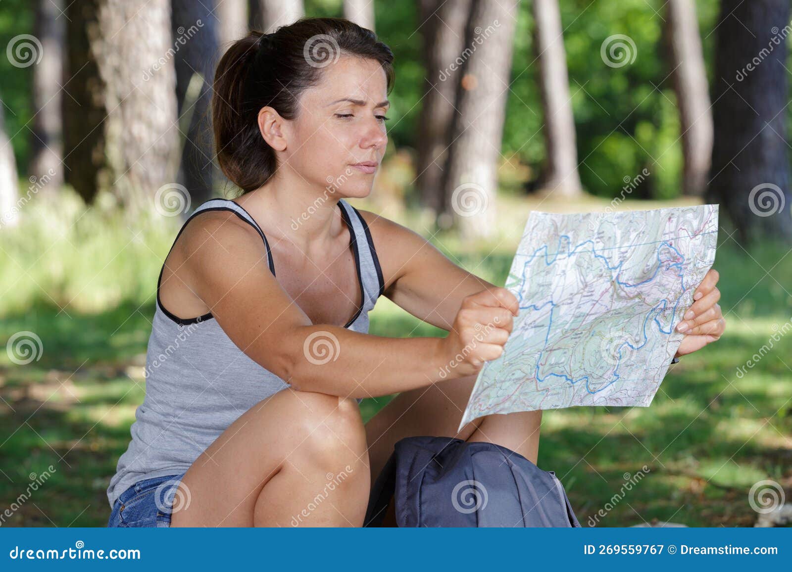Woman looking at map stock image. Image of planning - 269559767