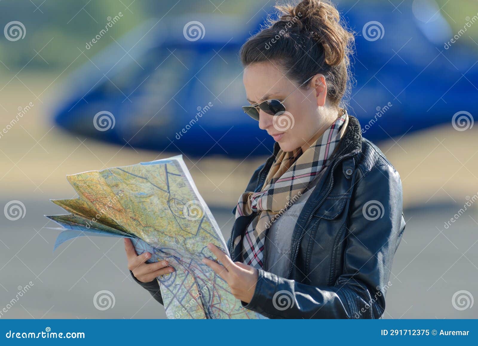 Woman Looking at Map Helicopter in Background Stock Image - Image of ...
