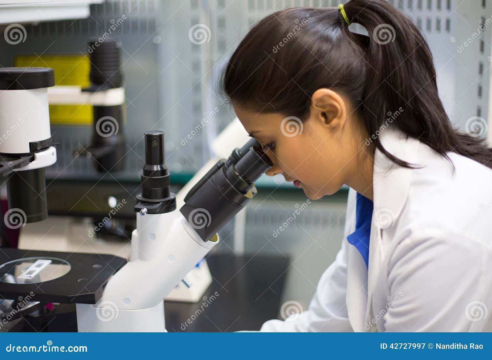 Woman Looking through Microscope Stock Image - Image of medical ...
